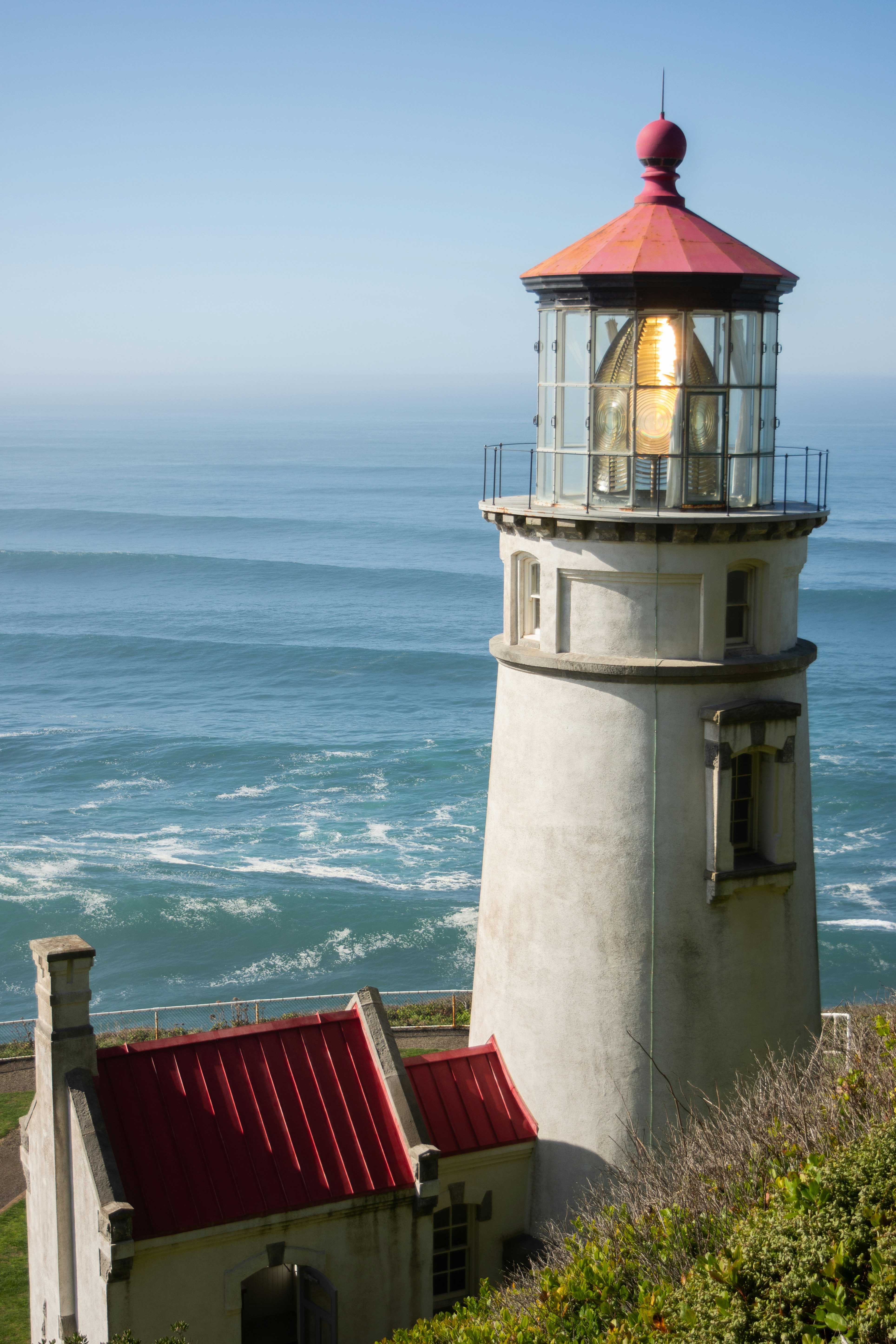 Crimson Lantern on the Cliff: A Lighthouse Over Calm Seas