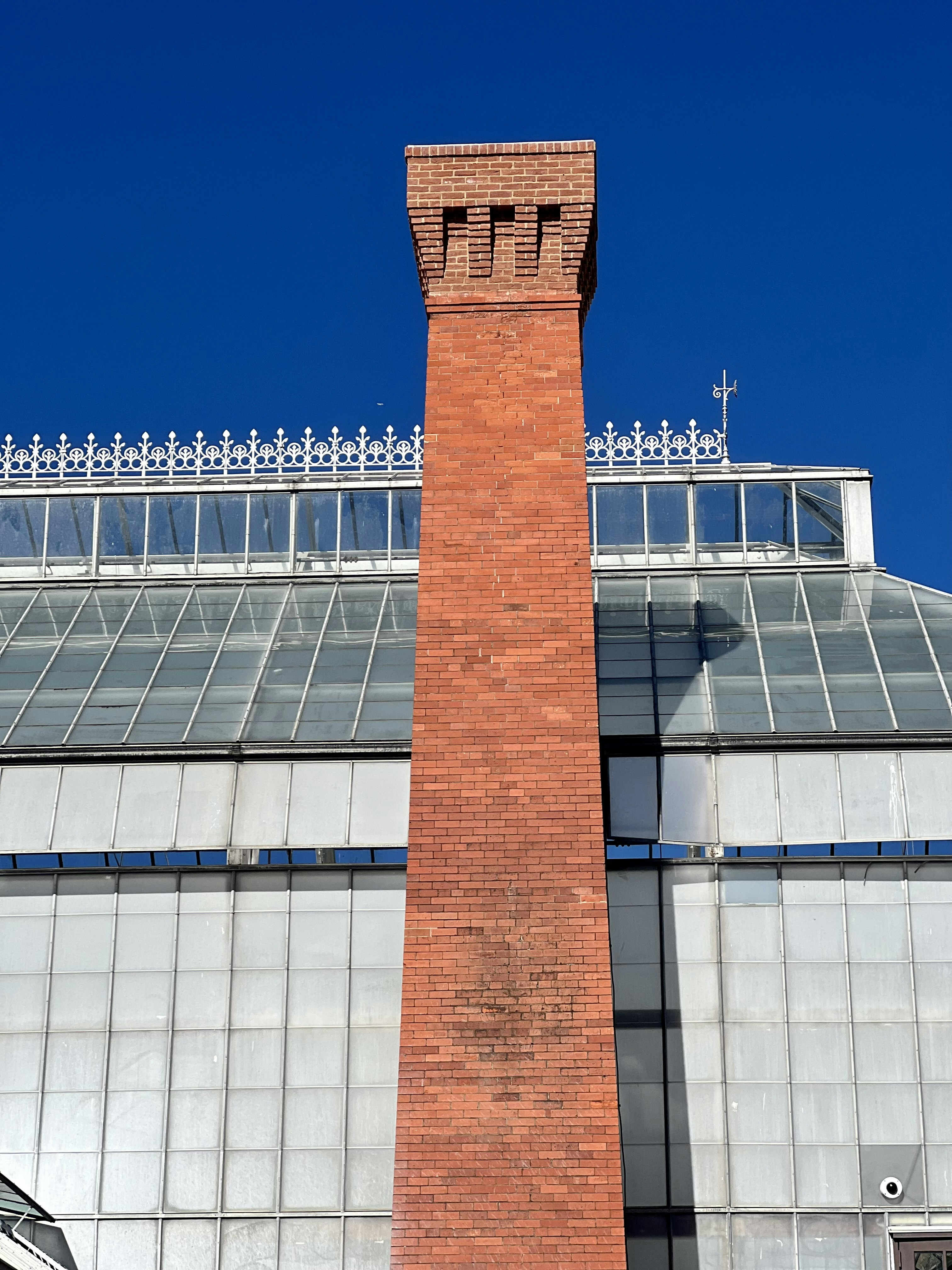 Brick Chimney Rising Against a Clear Blue Dome