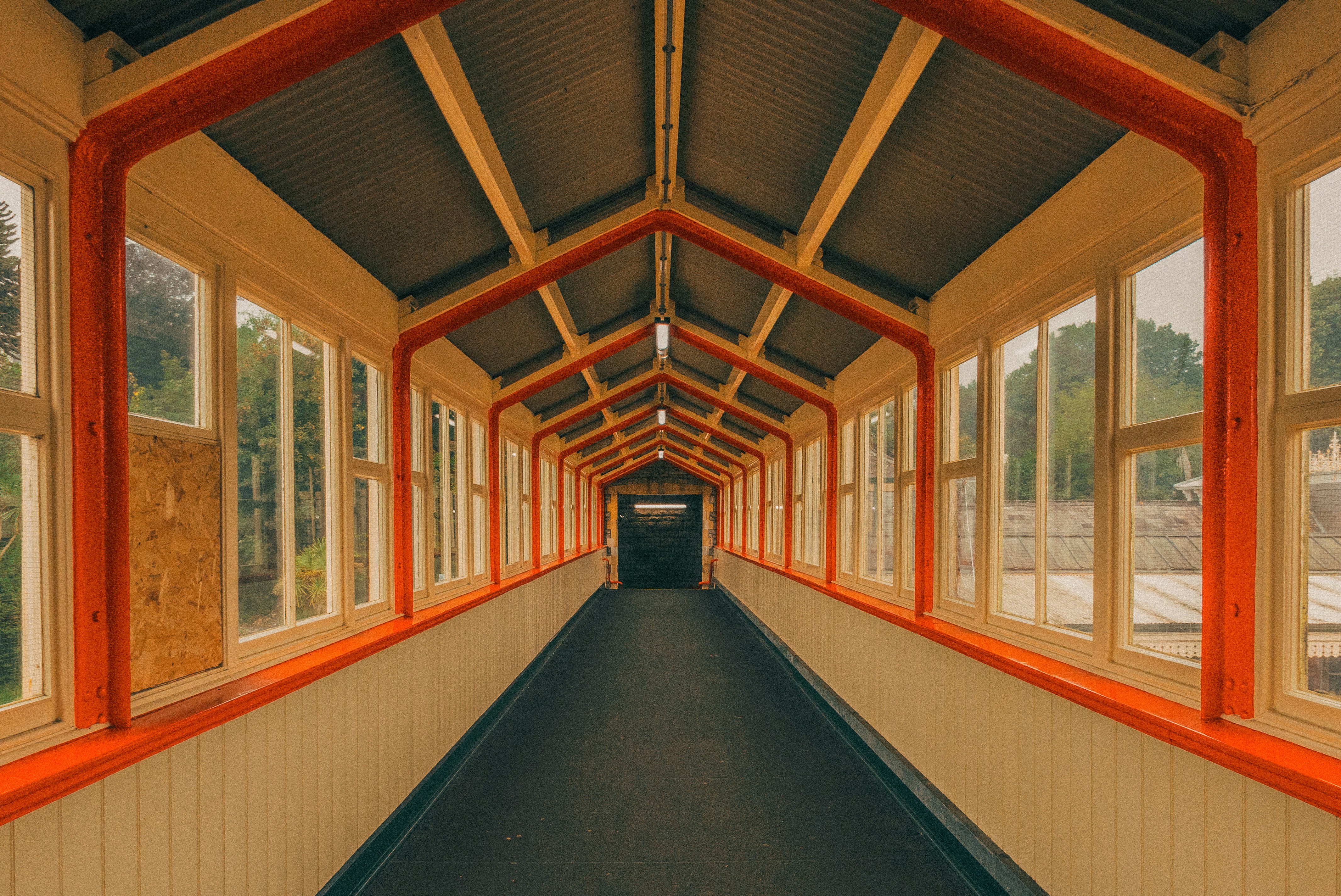 A long hallway with orange trim and windows photo – Free Film Image on ...