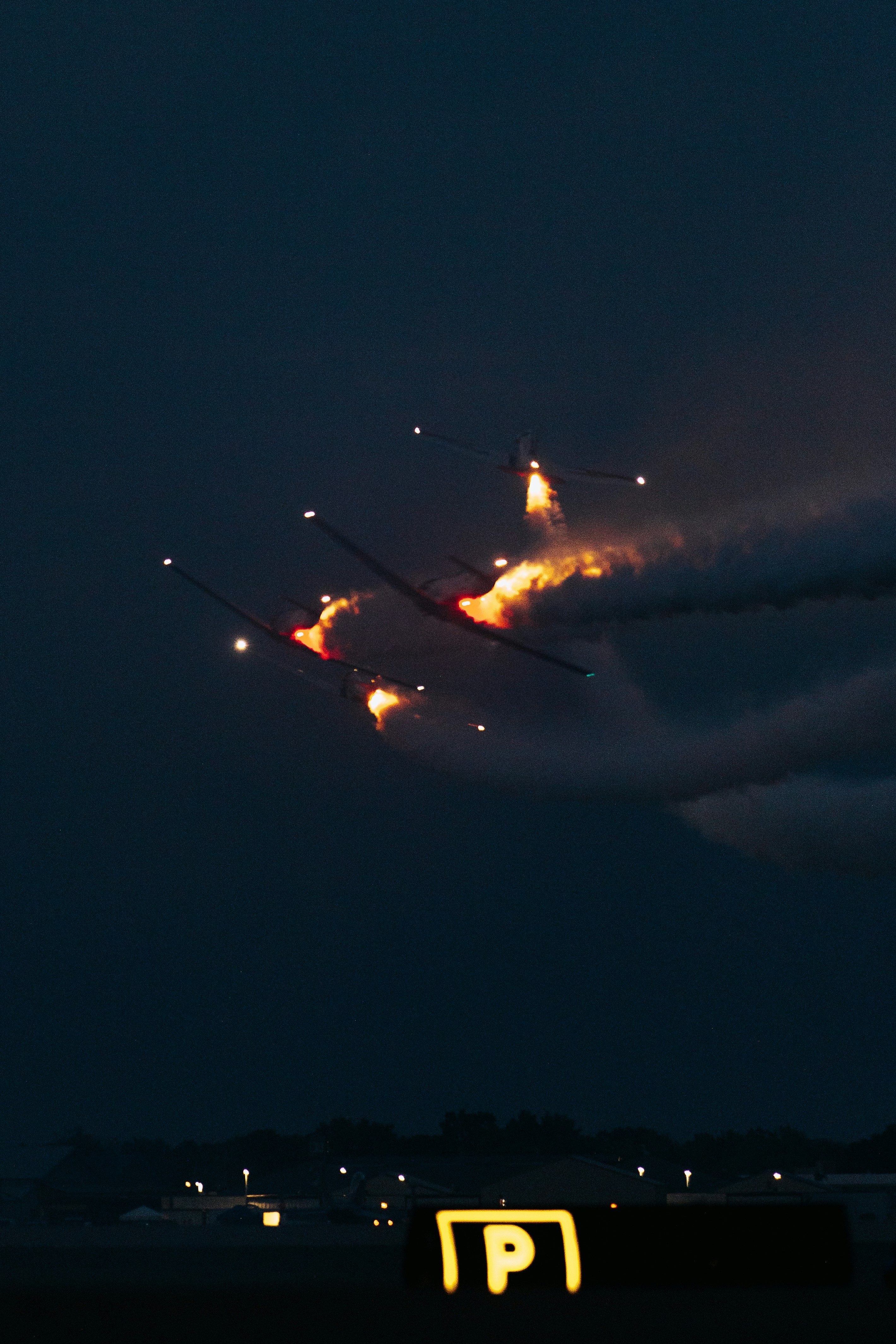 Nocturnal Formation: Fiery Trails Over a Runway