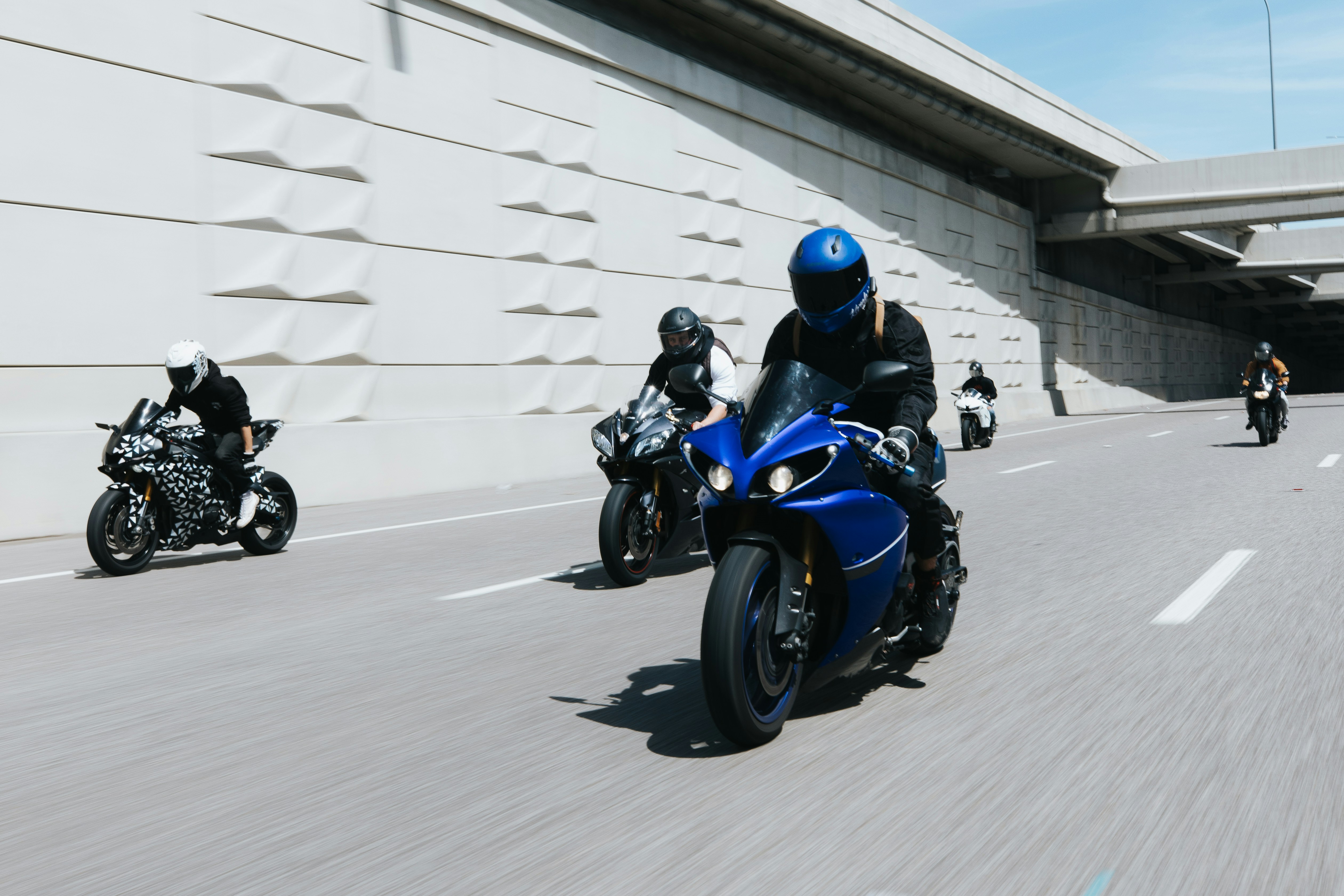 A group of people riding motorcycles down a street photo – Free Fun ...