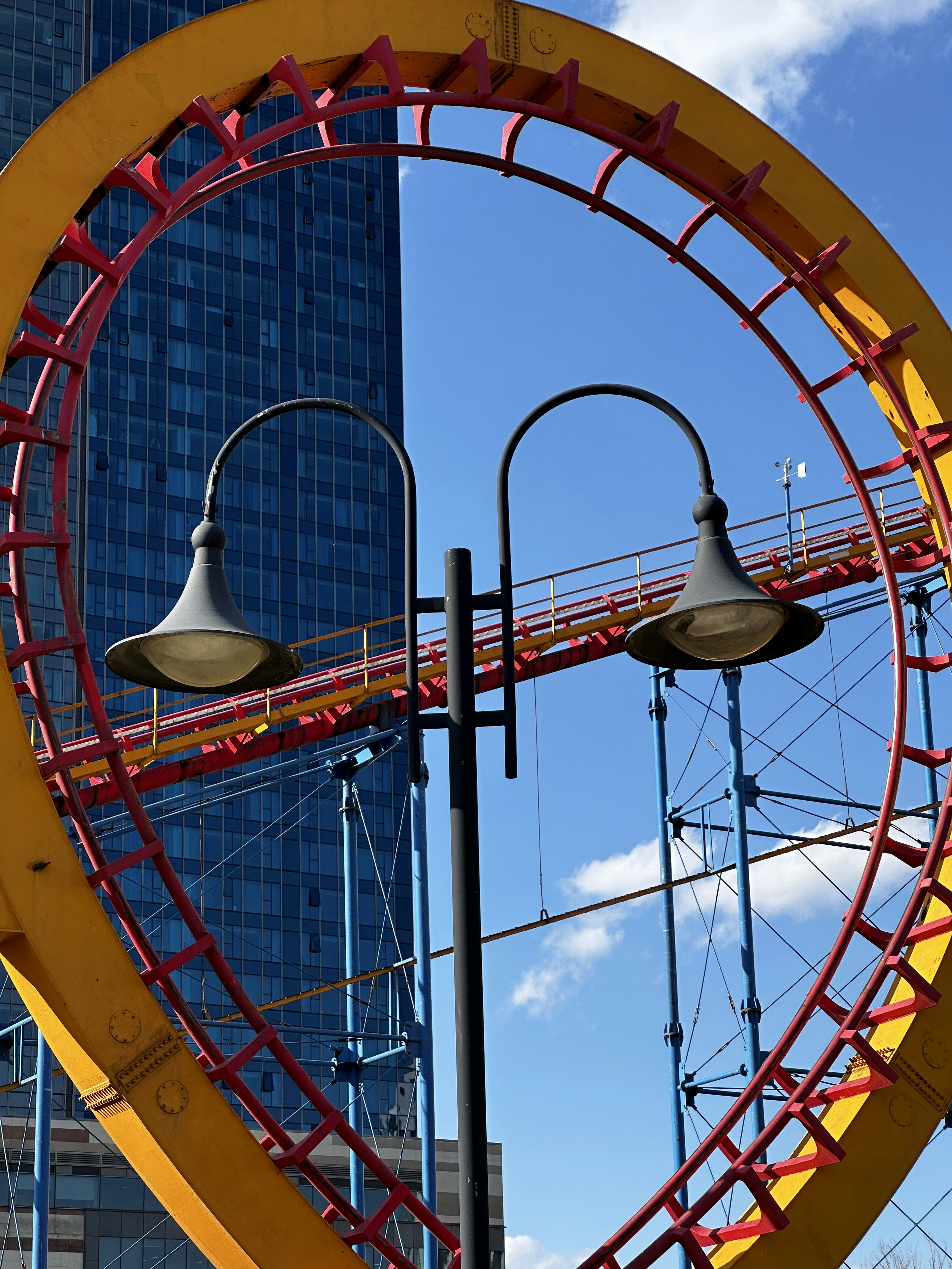 Golden Ringframe: Urban Geometry Framing a Blue Glass Skyscraper