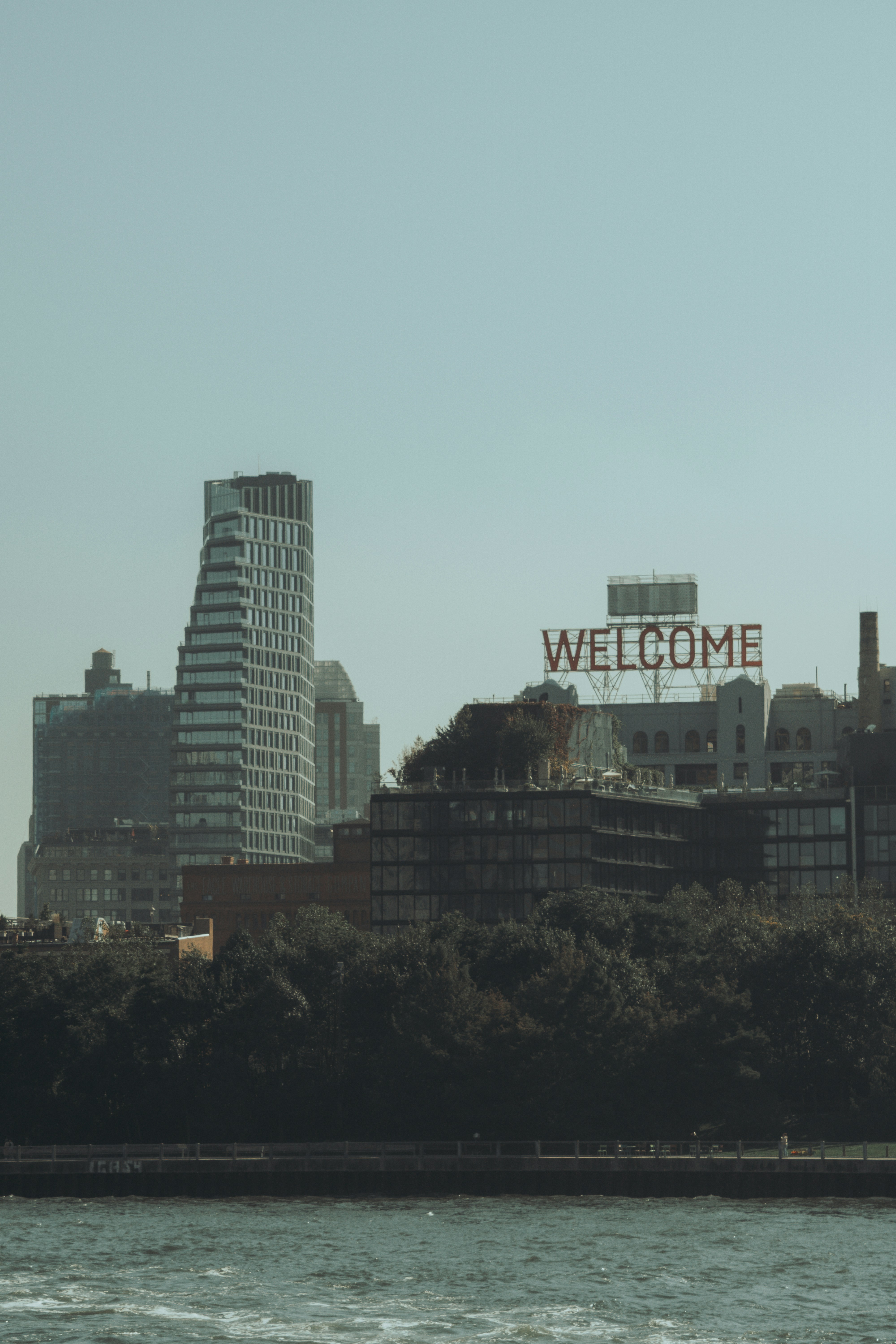 A large welcome sign on top of a building photo – Free Building Image ...