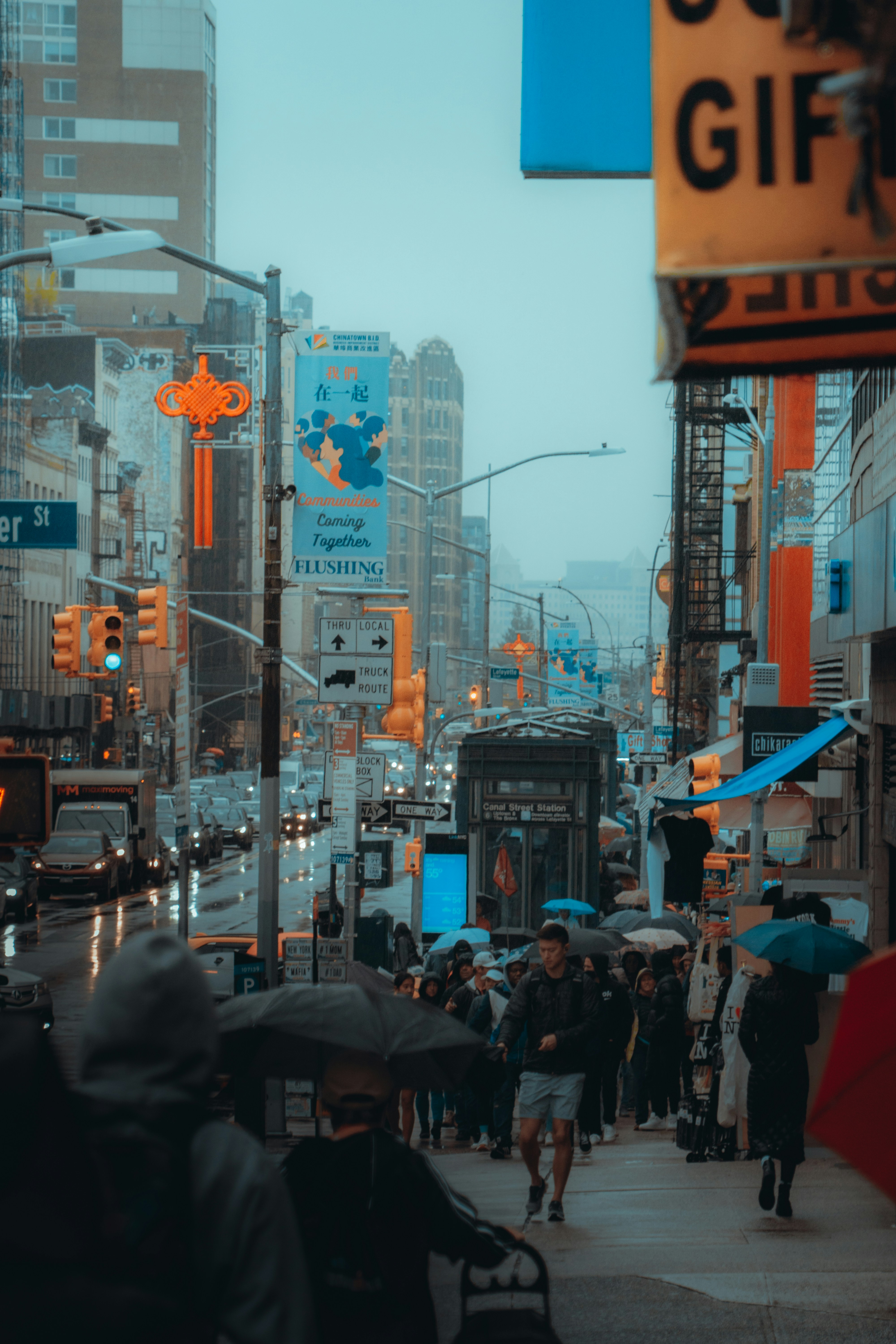 Umbrella Parade Under Neon Rain on a Busy City Street