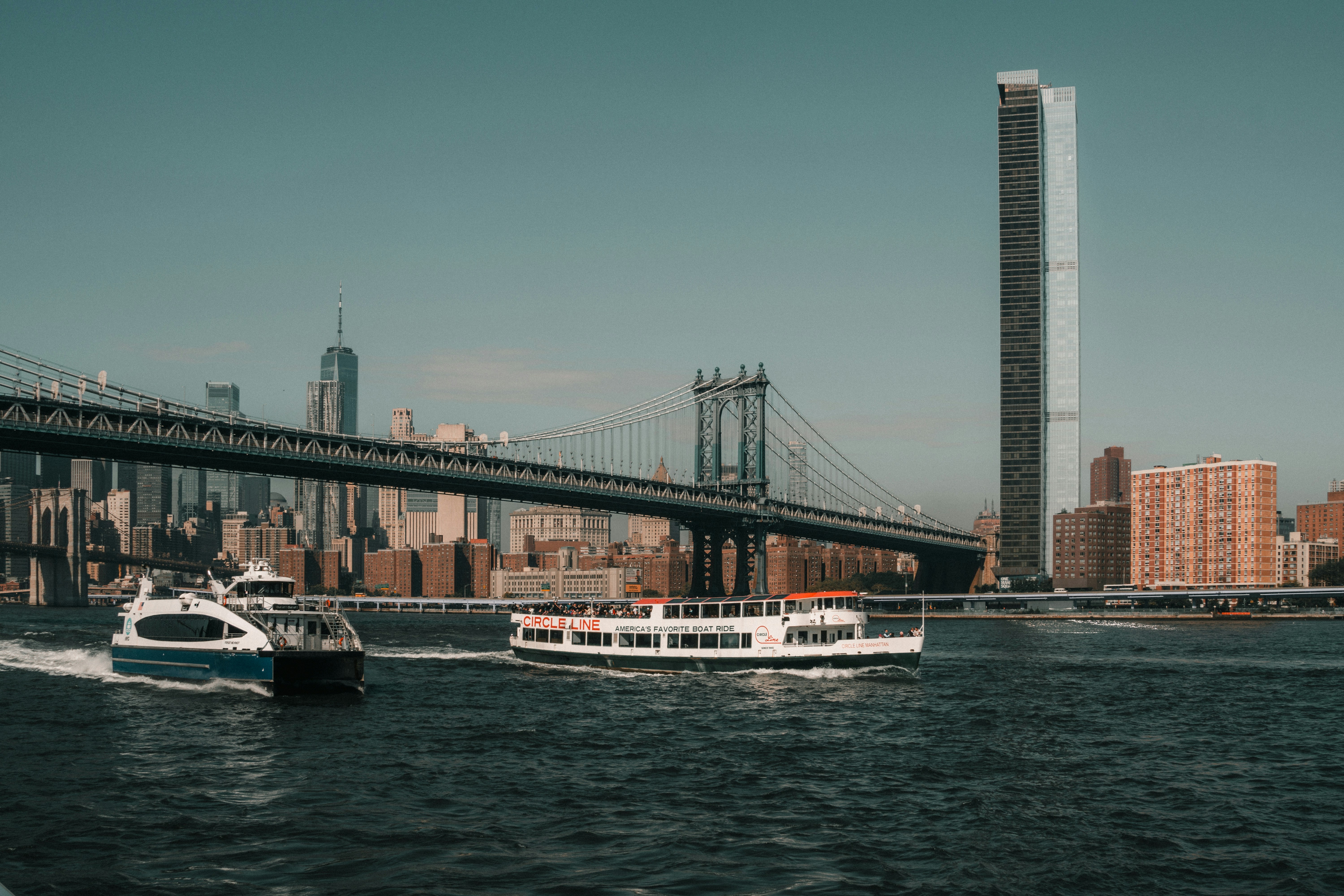 A boat traveling under a bridge in a body of water photo – Free ...