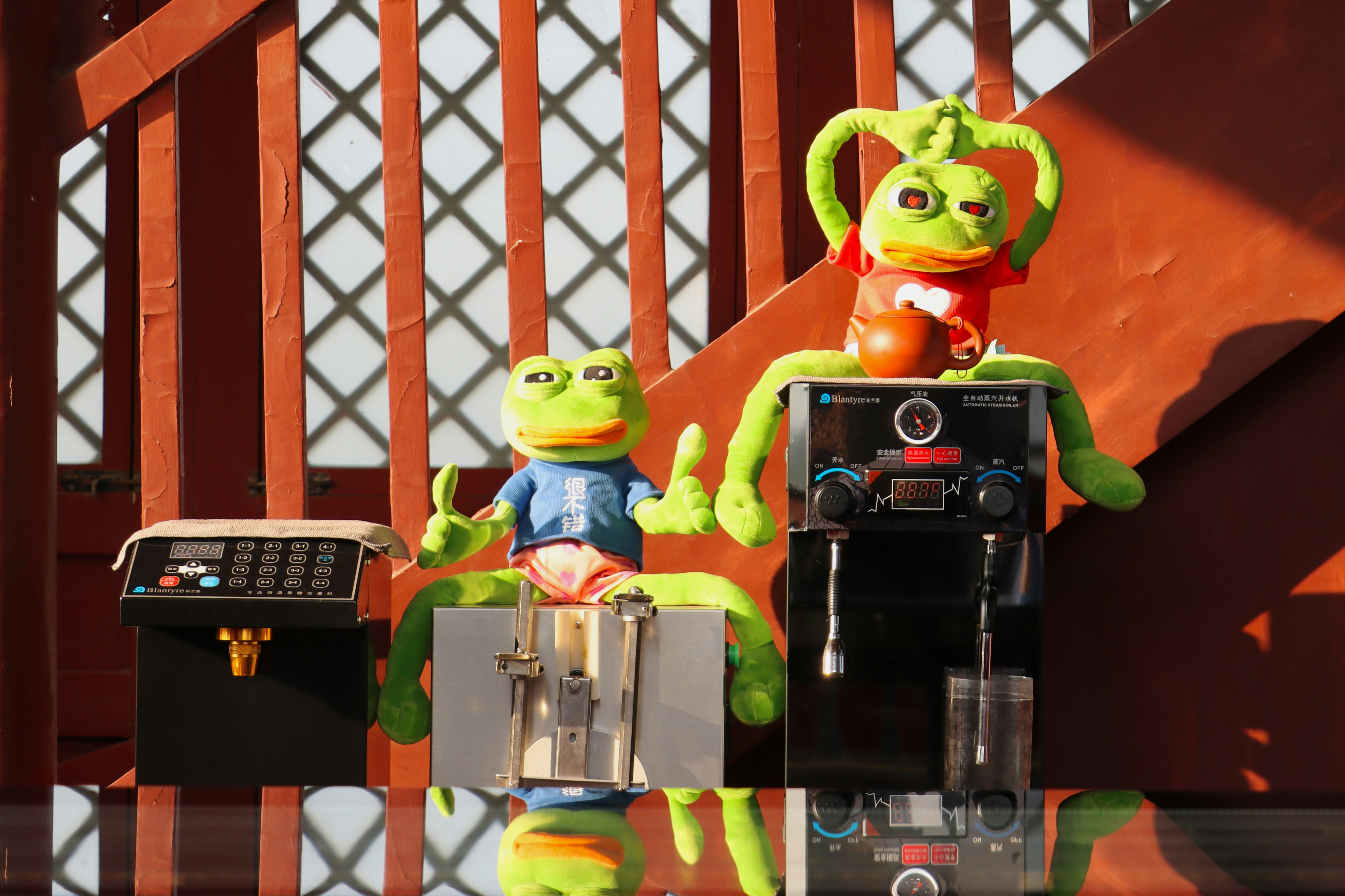 a couple of stuffed animals sitting next to a machine