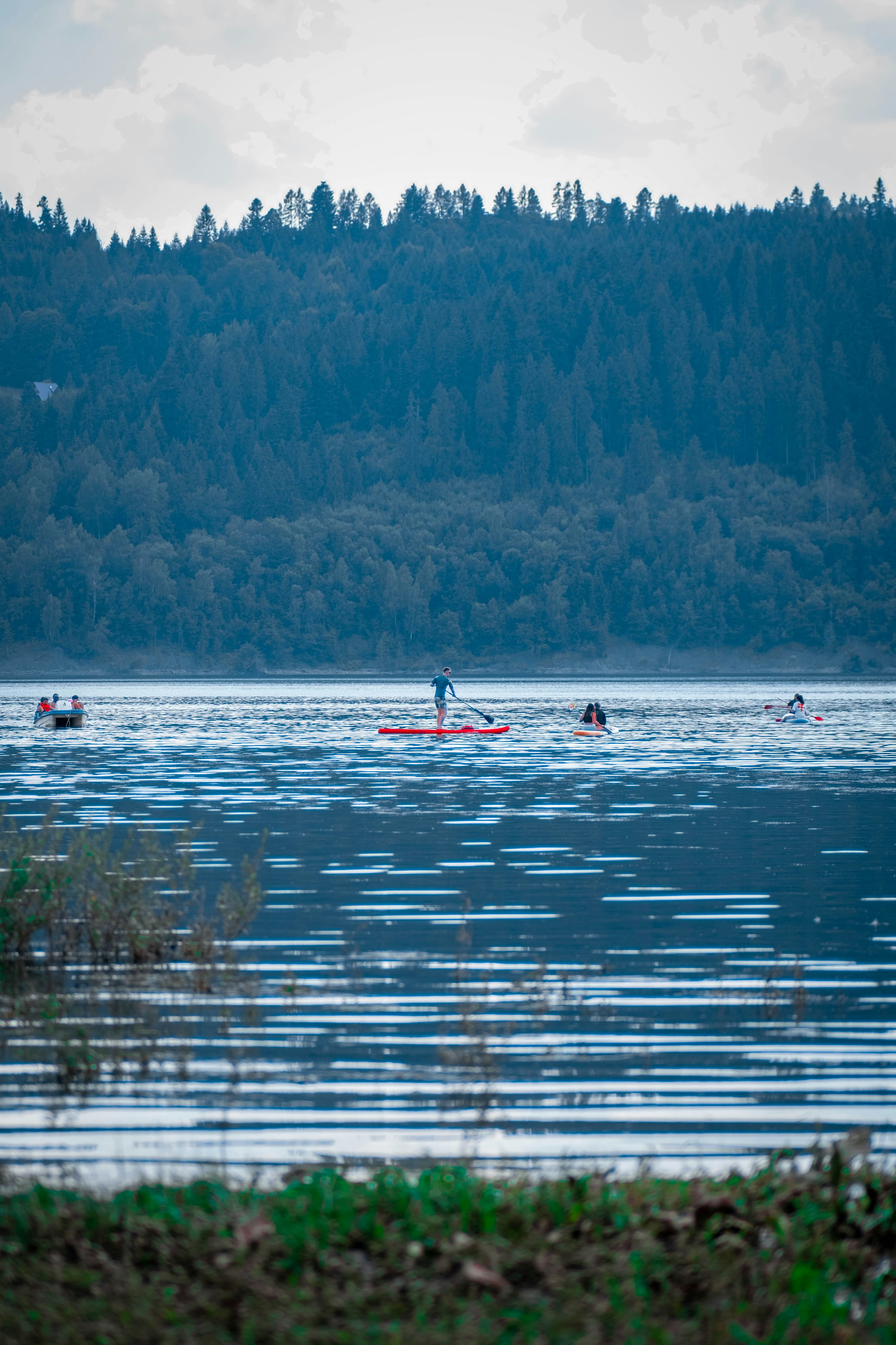 A group of people in canoes paddling on a lake photo – Free Iphone ...