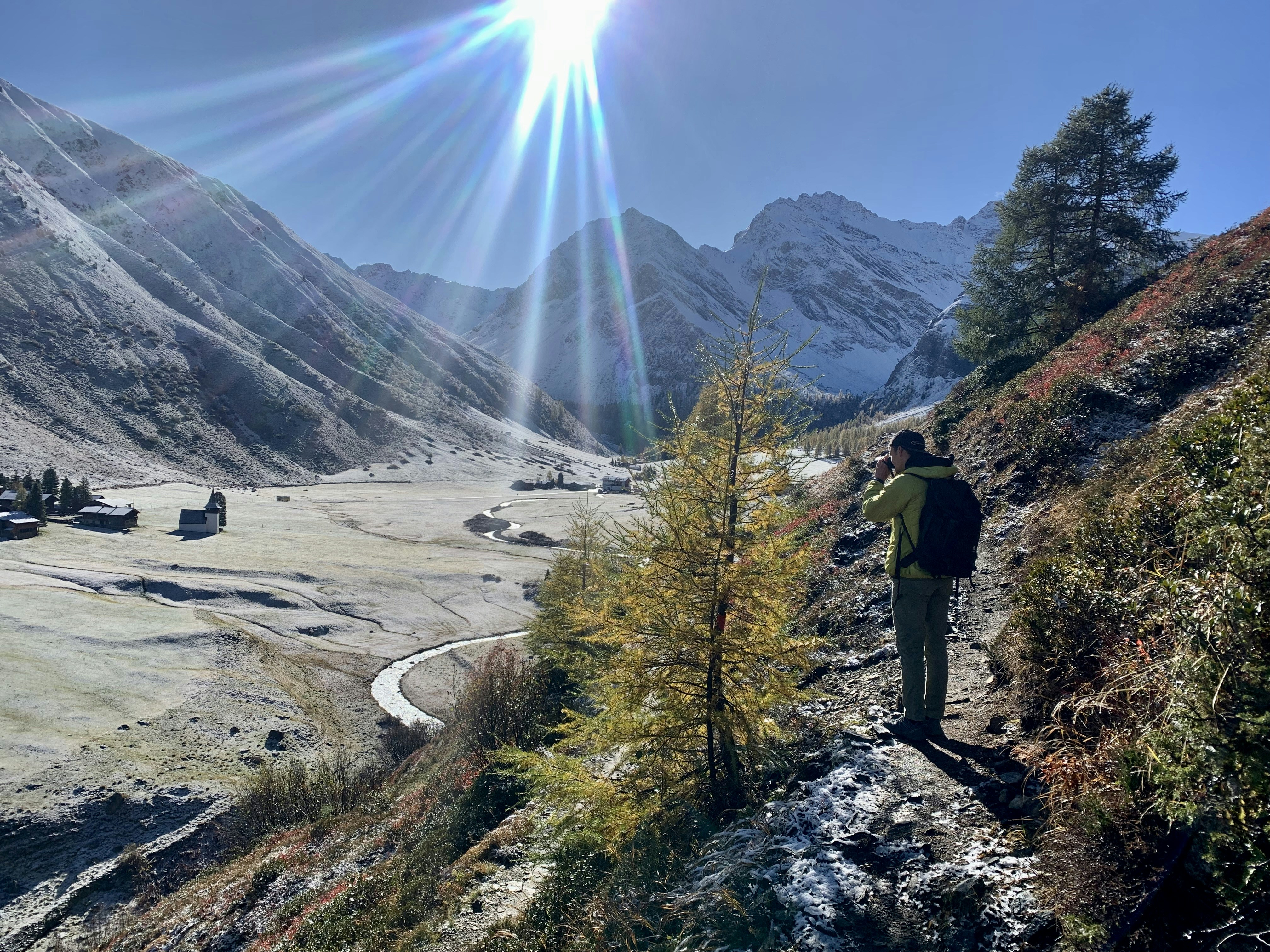 Ridgebound Wanderer under a Radiant Alpine Sky