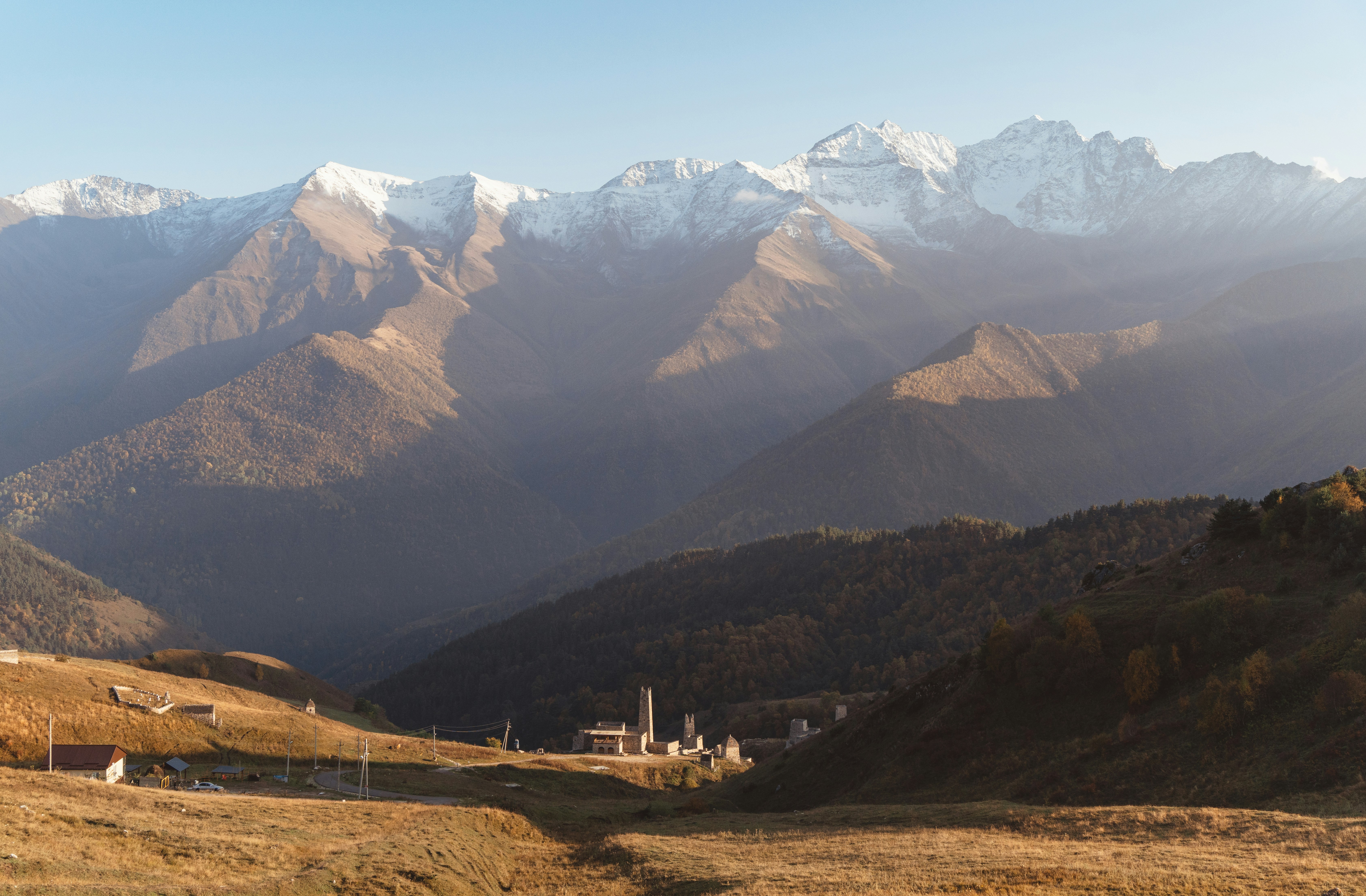 Dawn Over Snow-Crowned Giants: A Quiet Valley Beneath Rugged Ridge