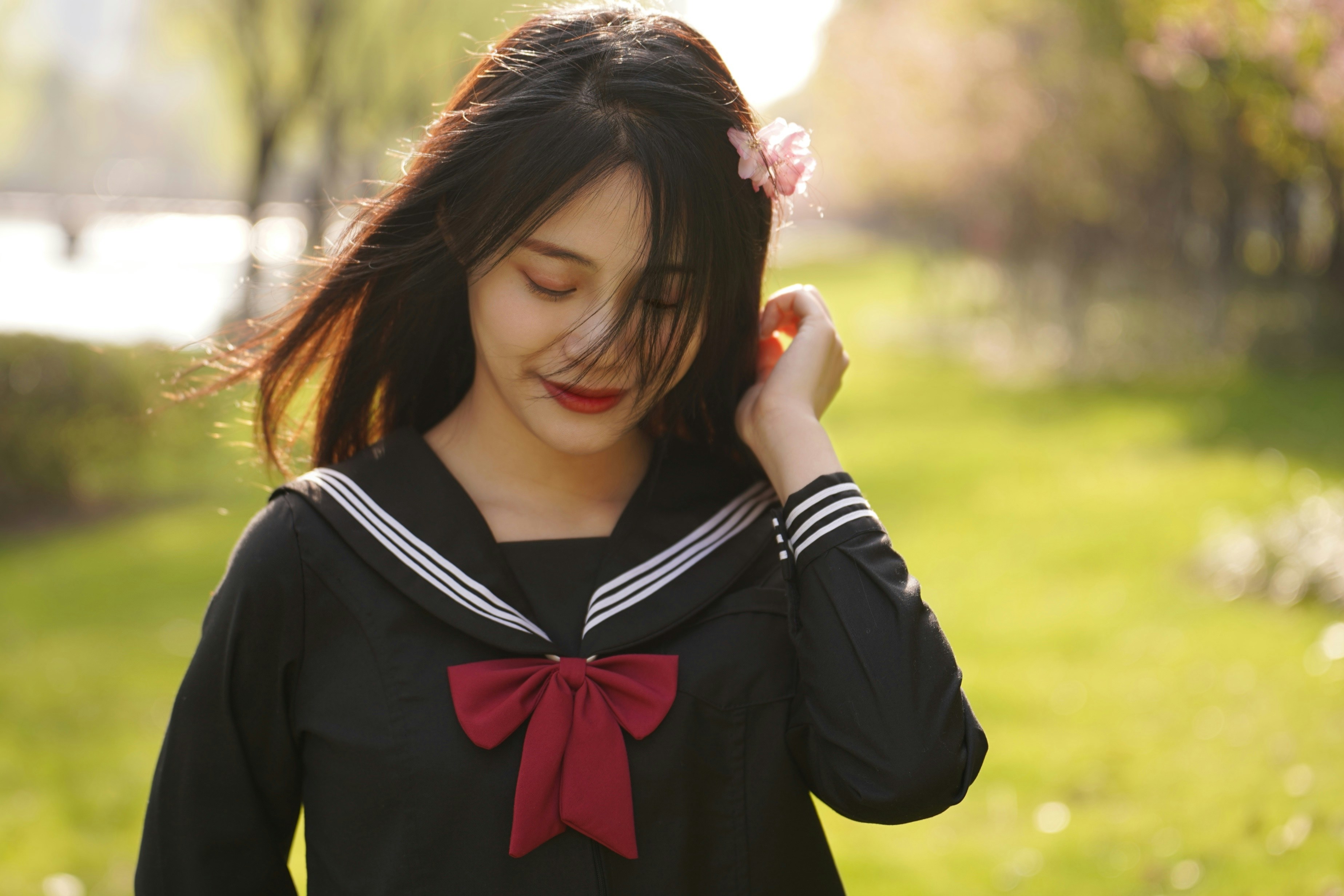 A woman in a black shirt with a red bow around her neck photo – Free ...
