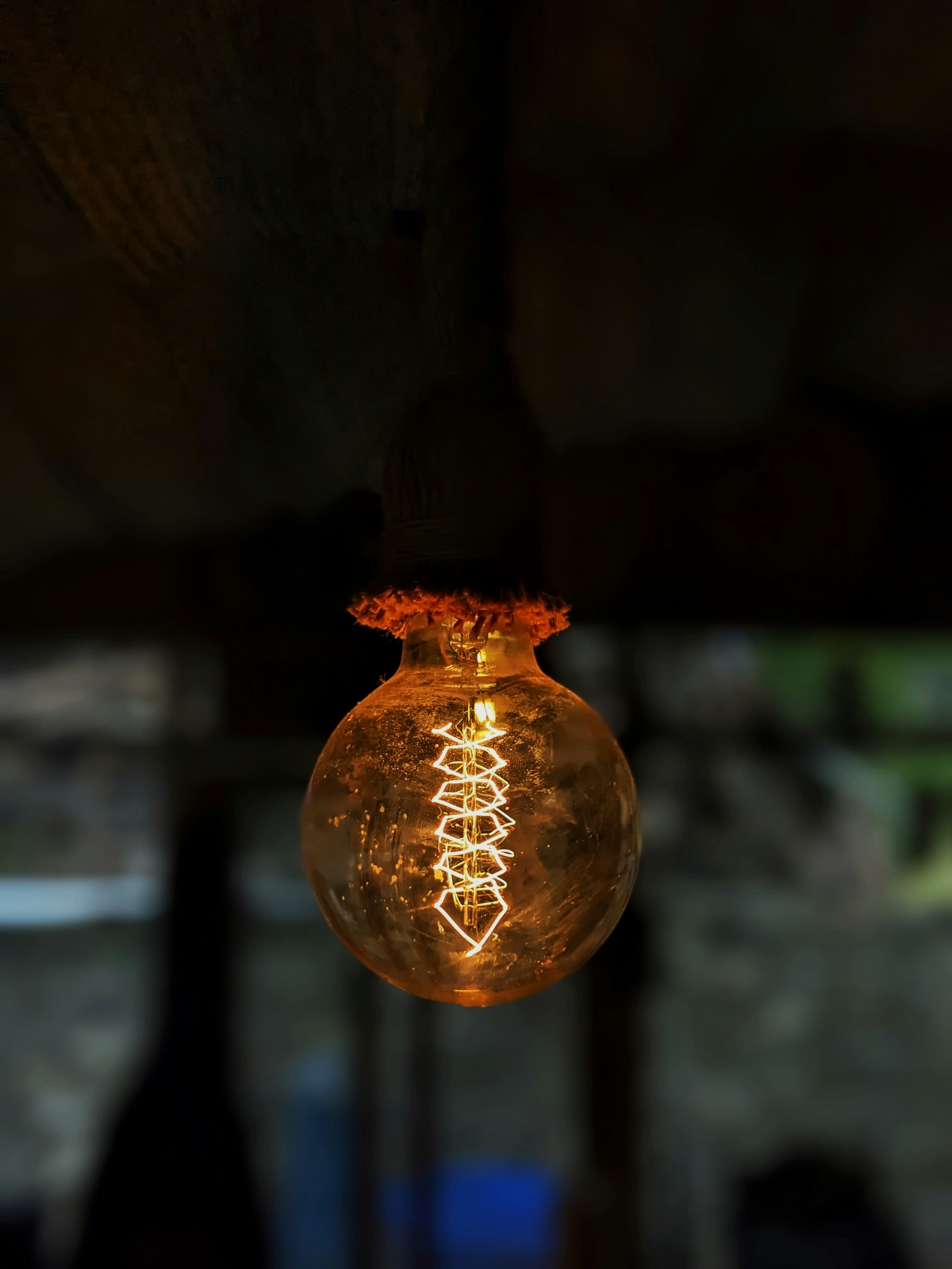 Orb of Ember: A Vintage Bulb Illuminates the Shadowed Room