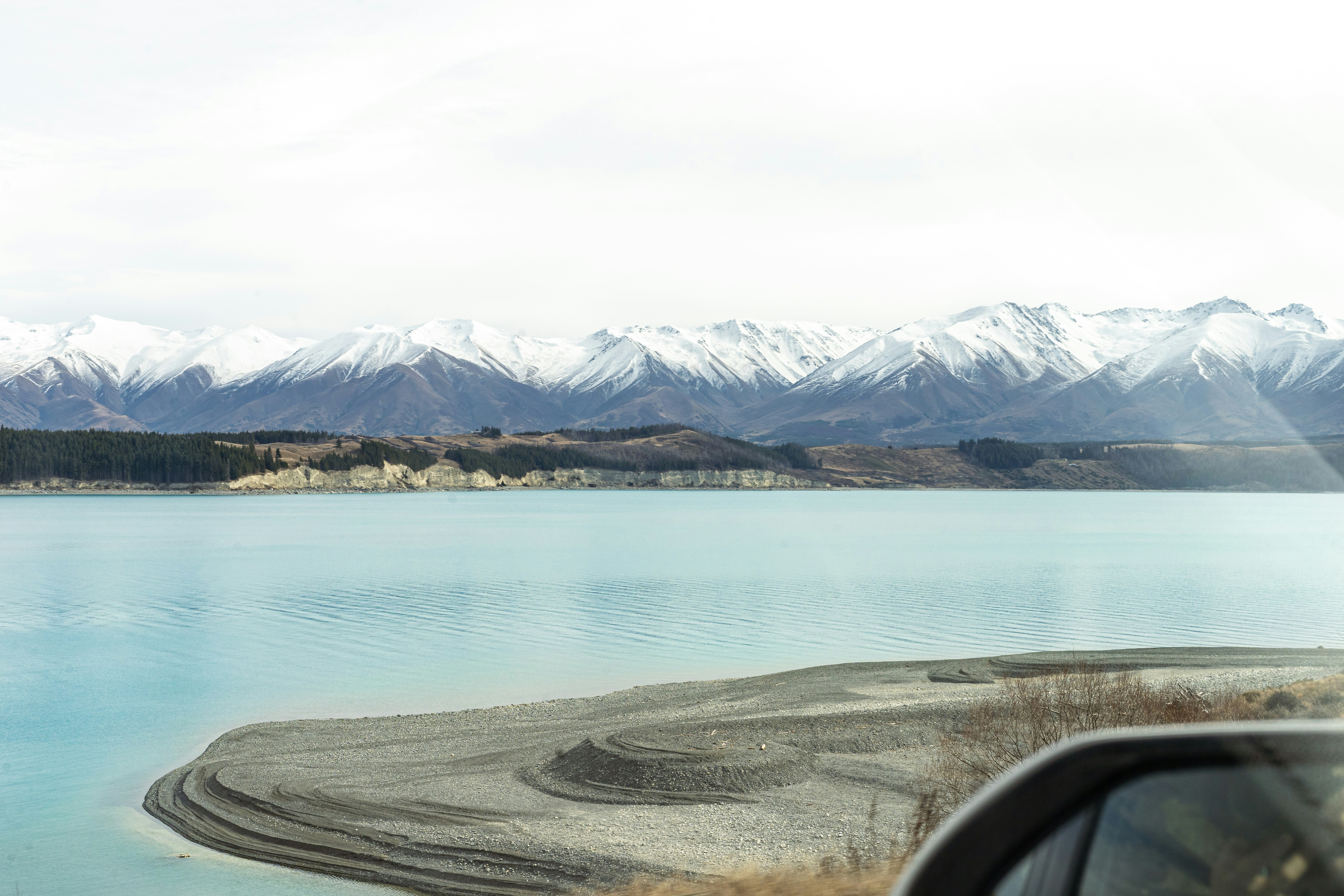 Azure Lake at the Foot of Snow-Capped Ranges, Seen from a Car Window