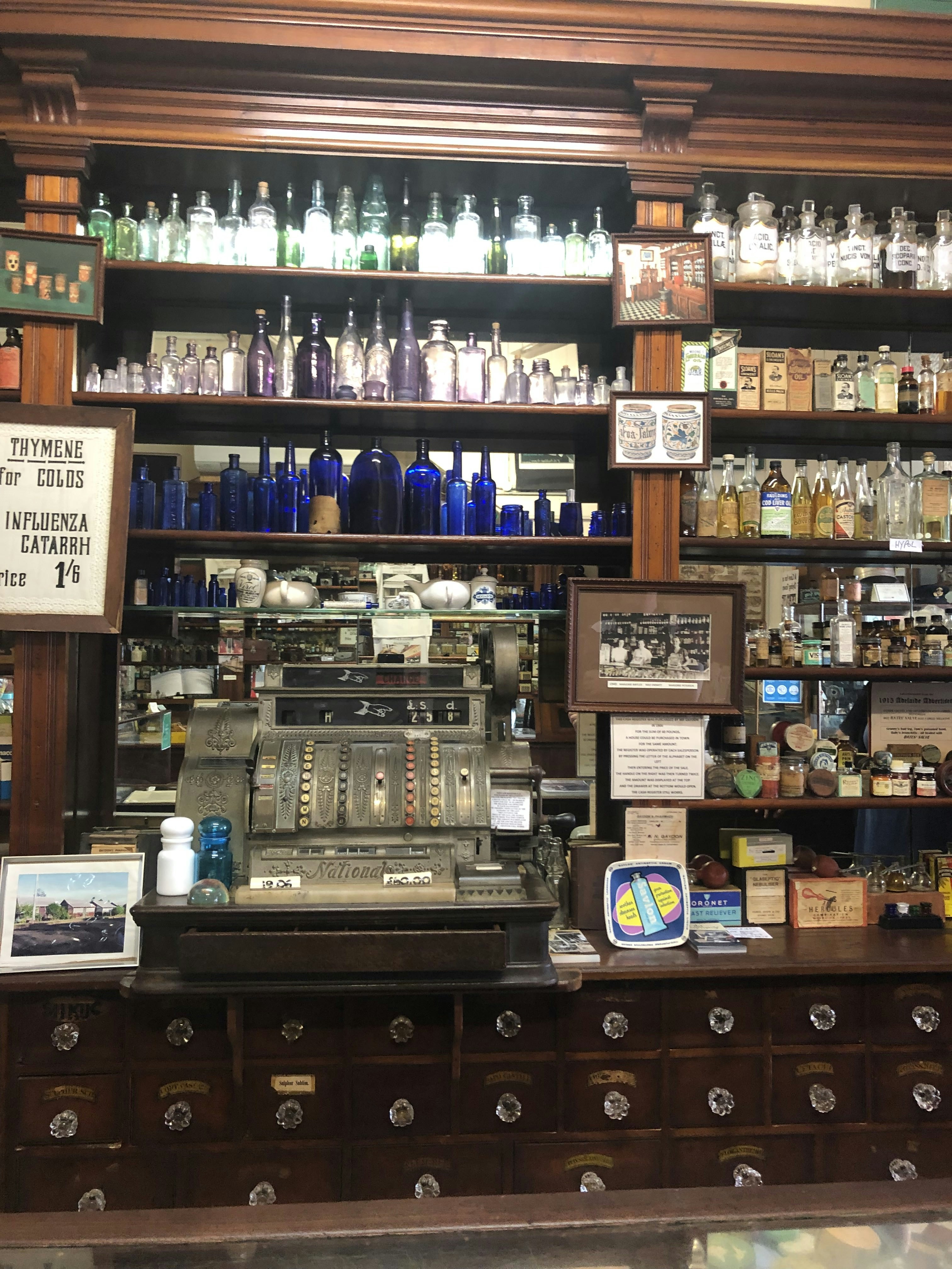 The Counter of Bottled Midnight: A Vintage Pharmacy Scene