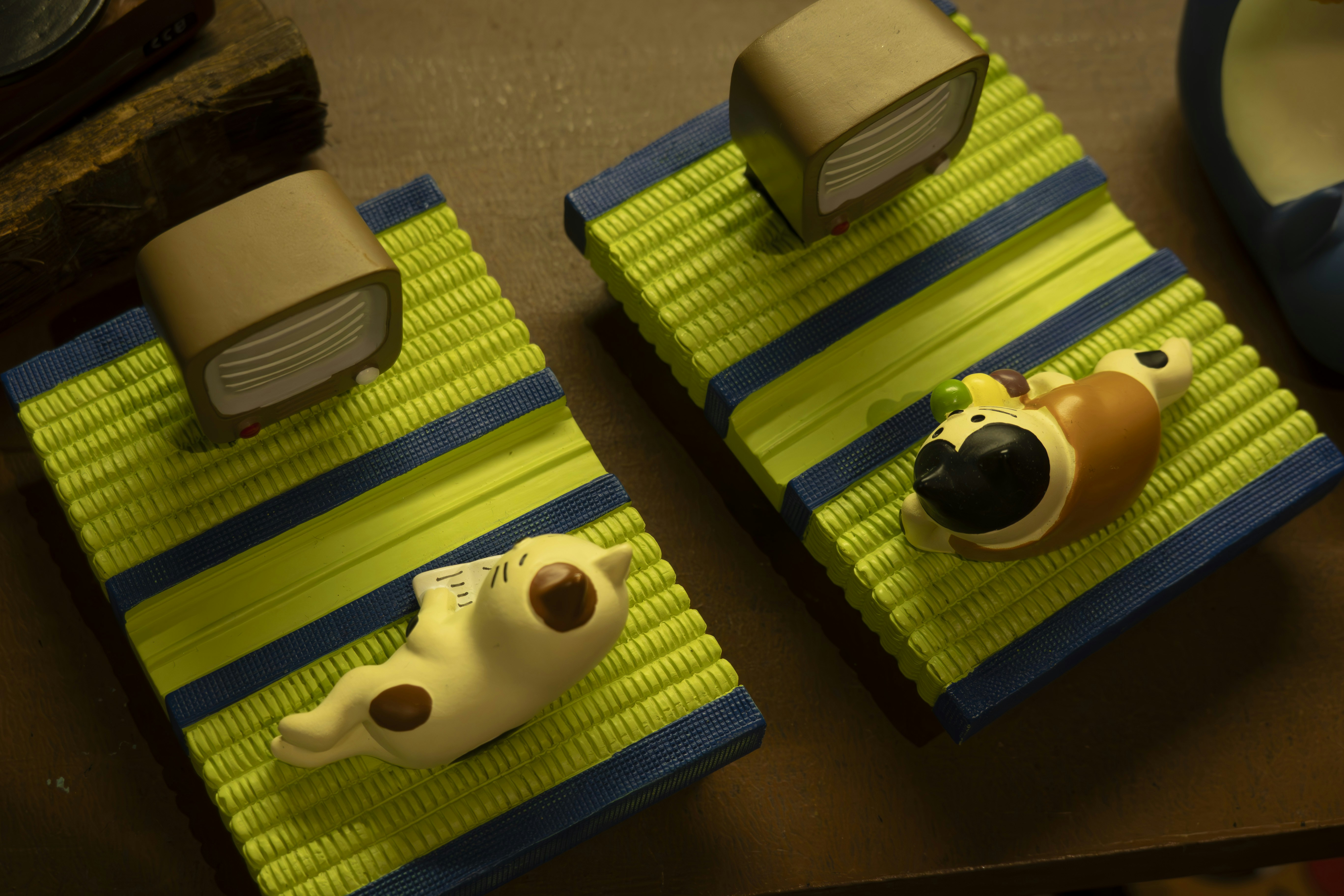 Amber Desk Diorama: Two White Dog Figurines on Neon-Green Pedestals