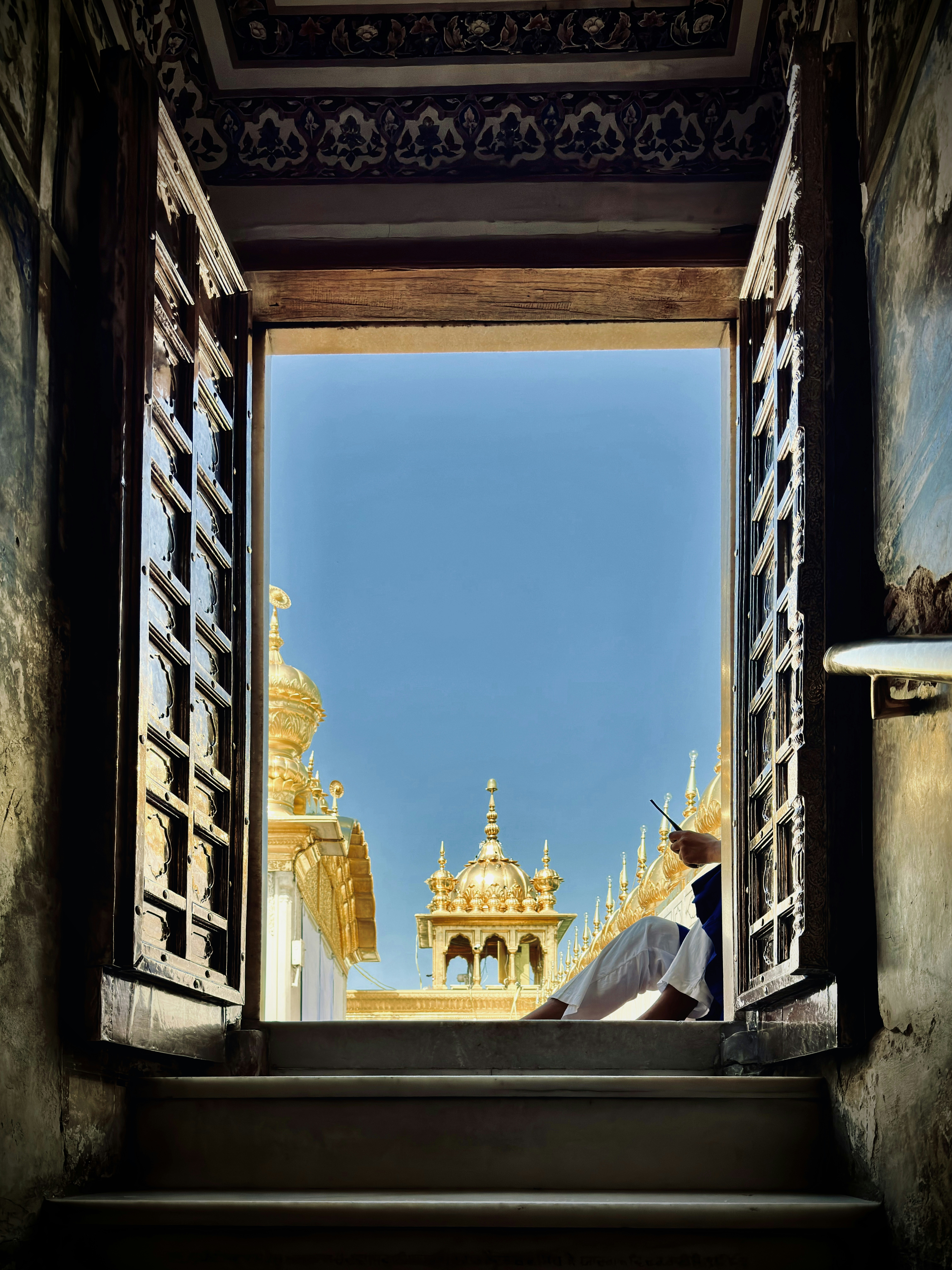 A view of a building through a window photo – Free India Image on Unsplash