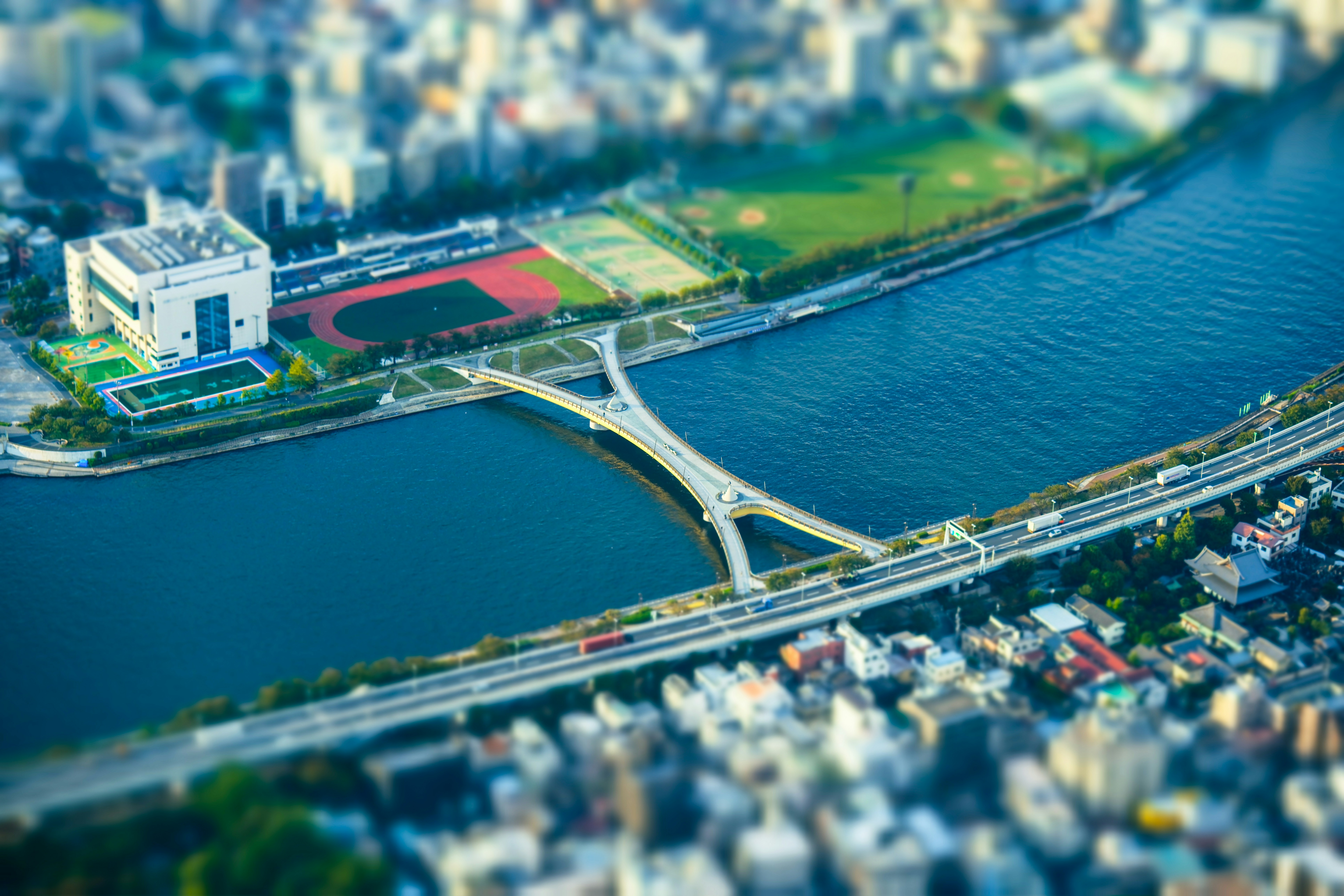Bridge Arc over a Miniature River: A Tilt-Shift Cityscape