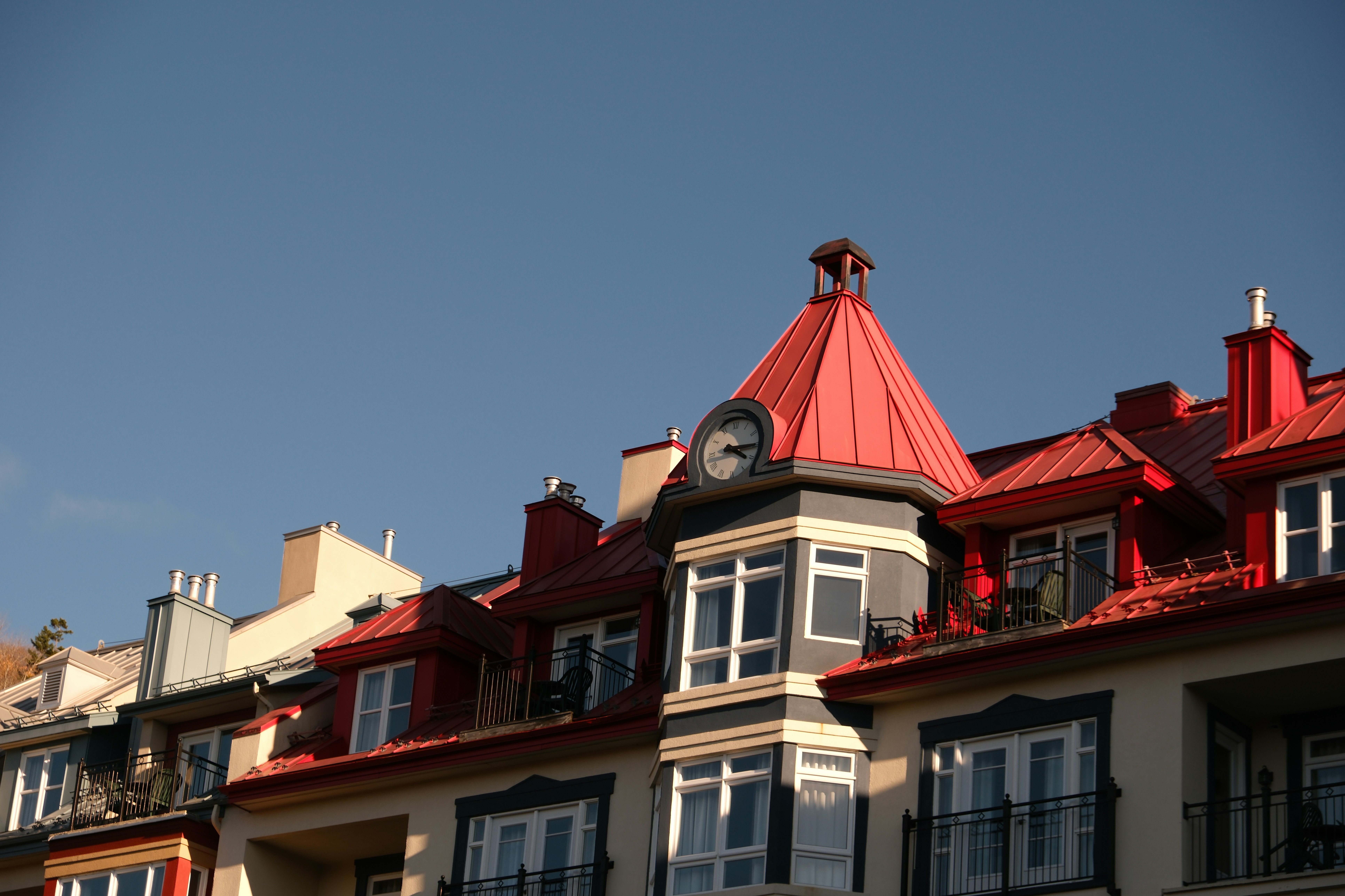 The Clocktower's Crimson Crown over Sunlit Facades