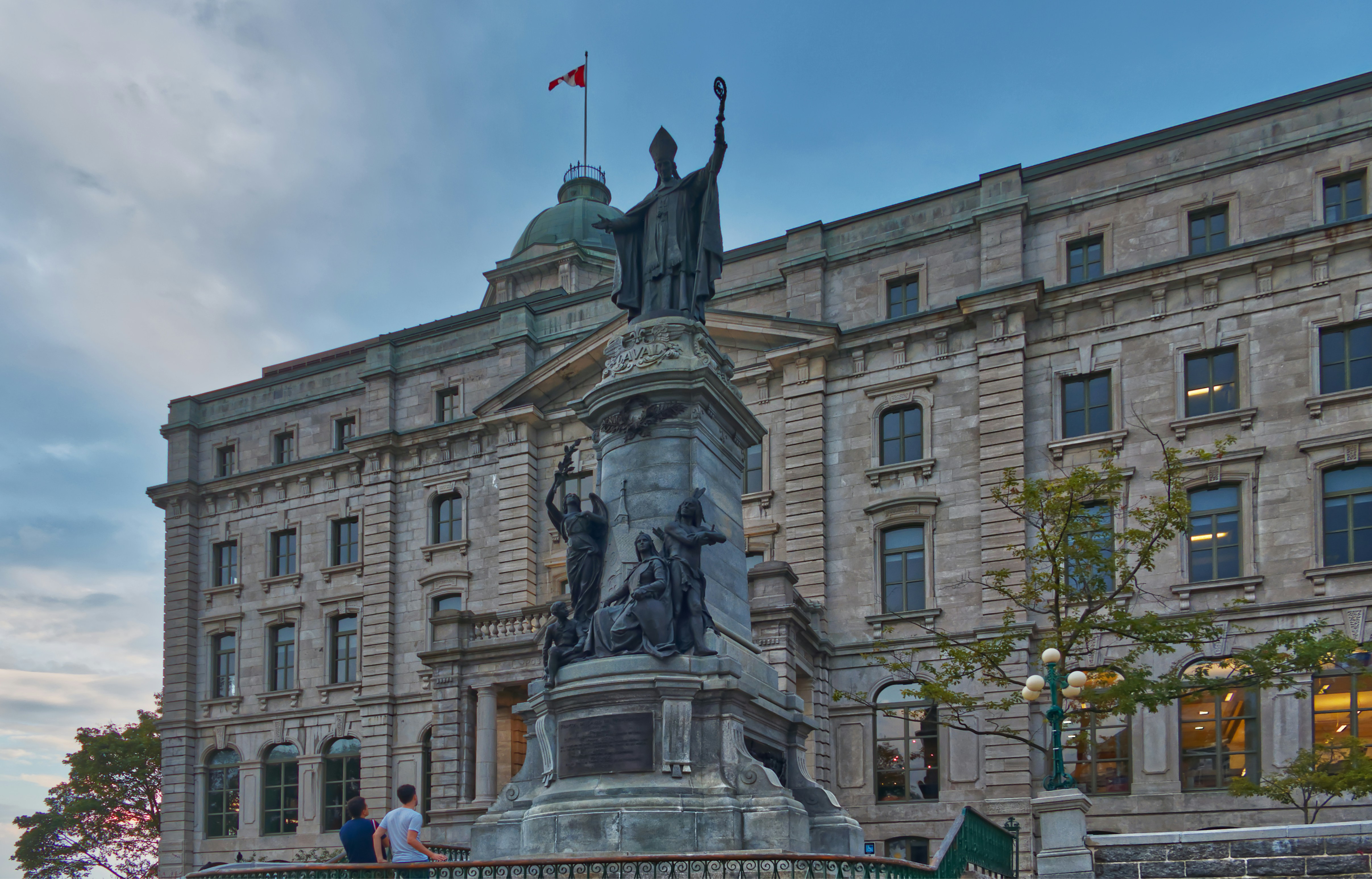 Monumental Quiet: A Statue Rising Before a Grand Civic Building at Dusk