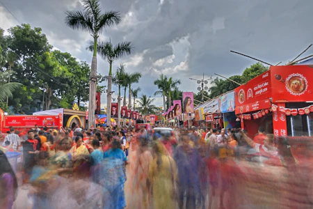 Palm-Lined Festival Corridor: Long-Exposure Chaos of Colorful Crowds