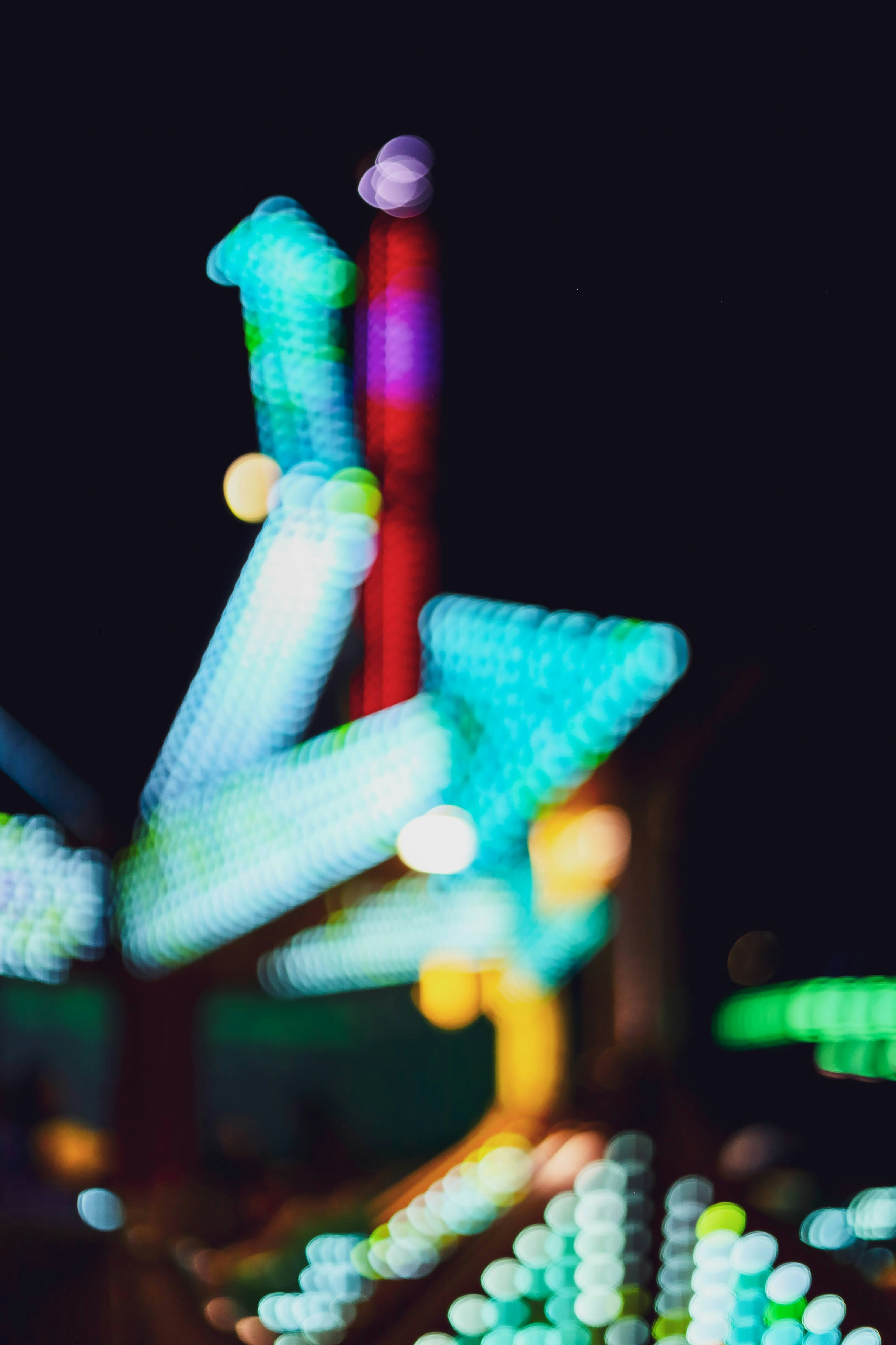 A blurry photo of a carnival ride at night photo – Free Night Image on ...