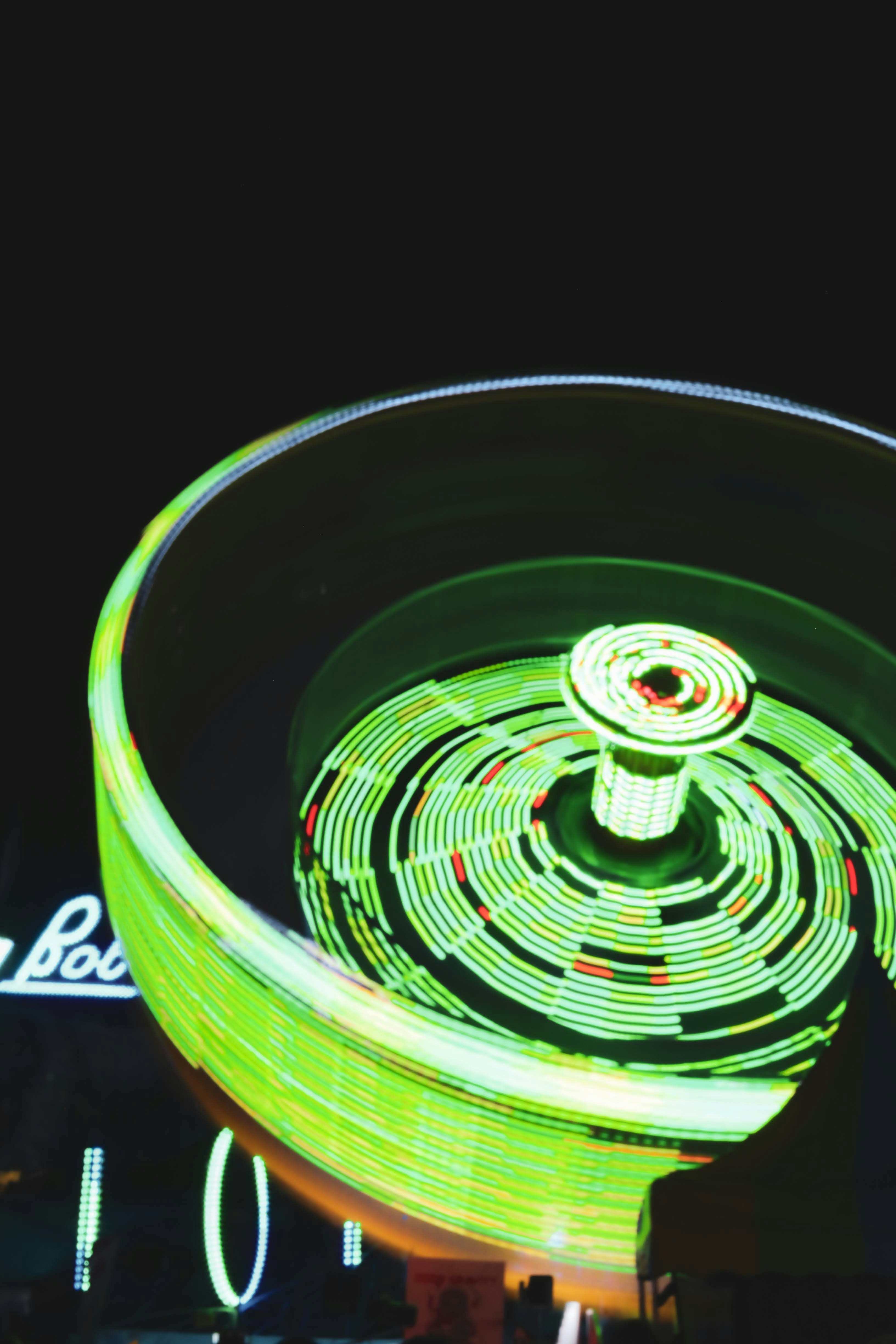 A blurry photo of a spinning object in the dark photo – Free Fair ...