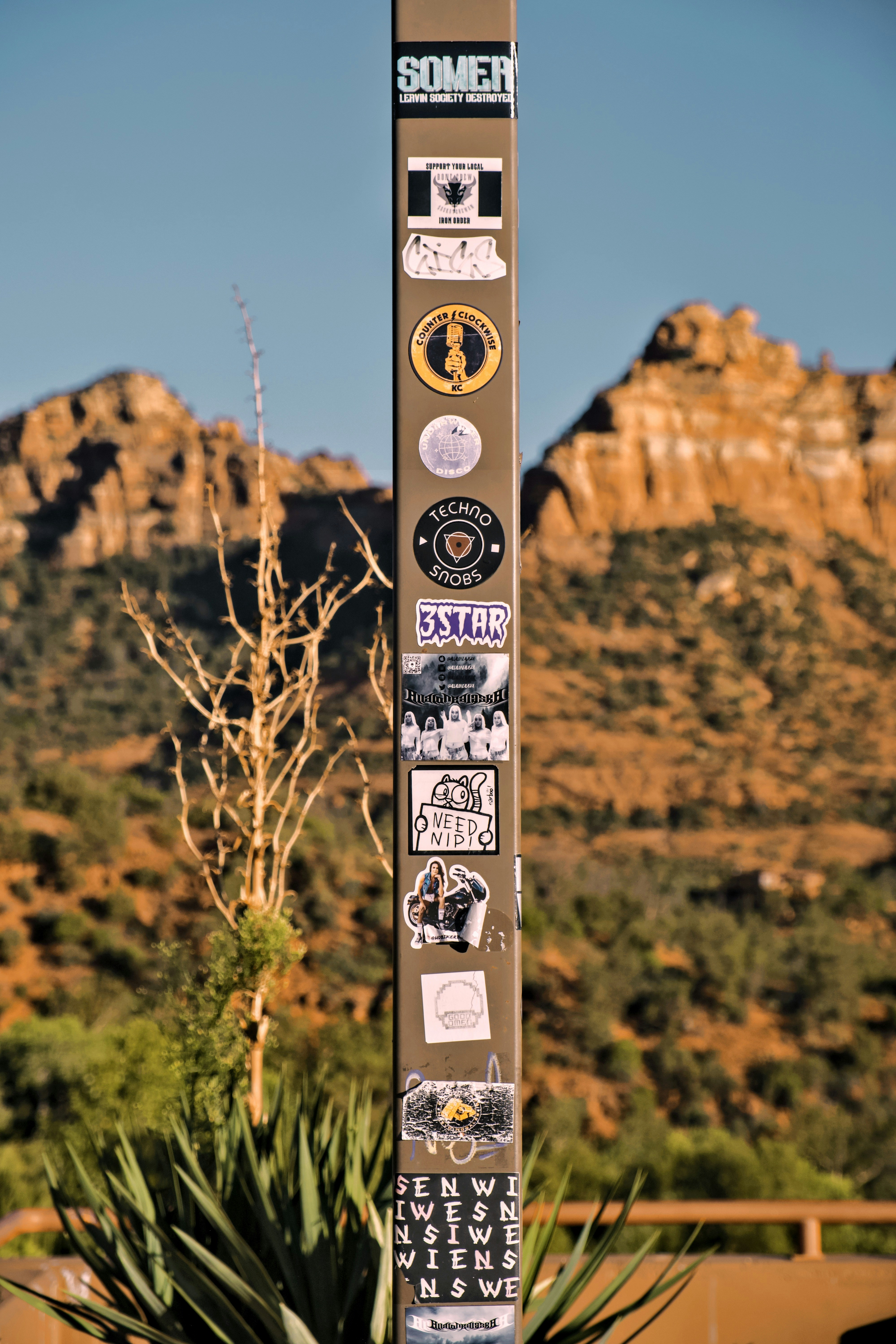 A pole with a bunch of stickers on it photo – Free Sedona Image on Unsplash