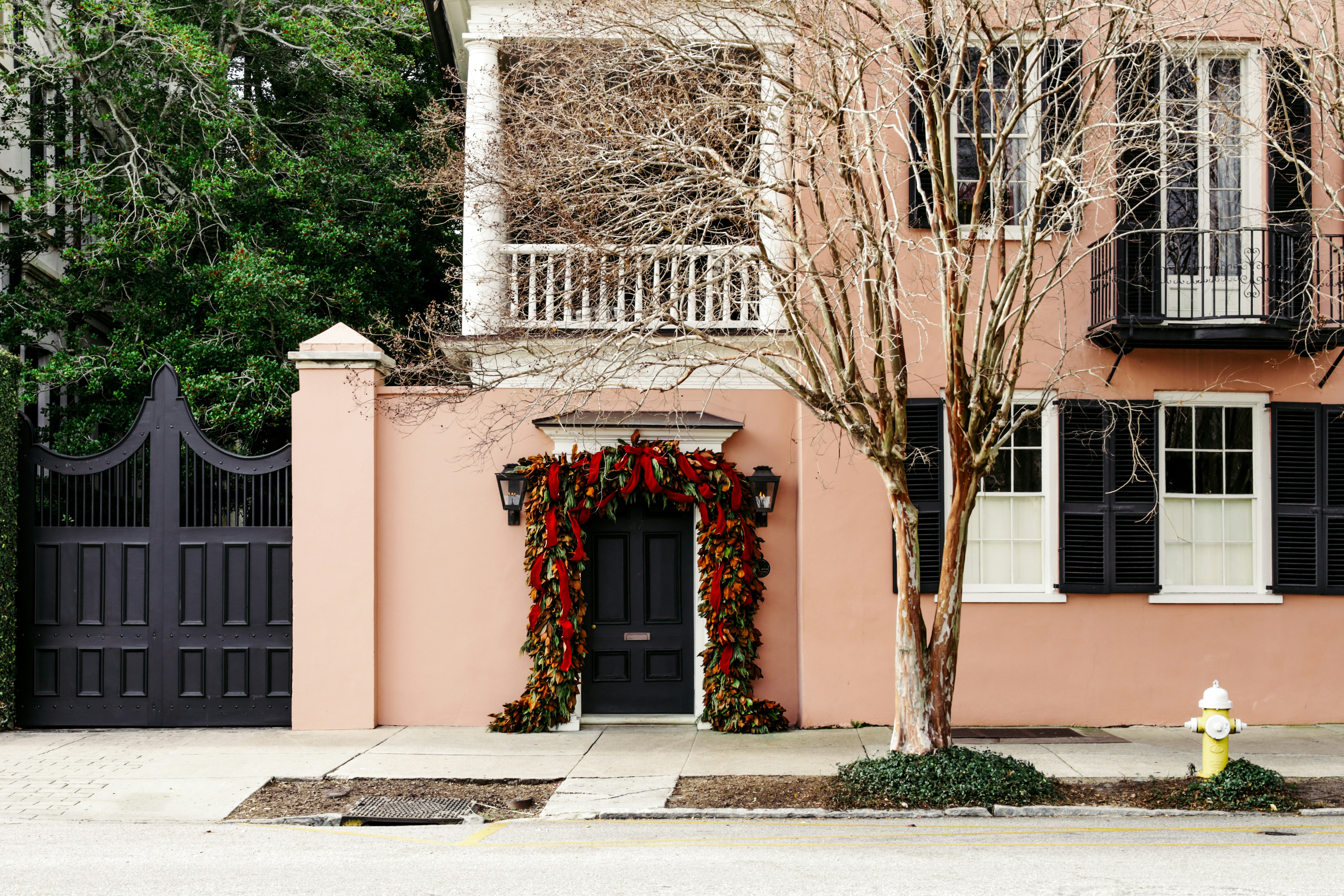 A pink house with black shutters and a white fire hydrant photo – Free ...