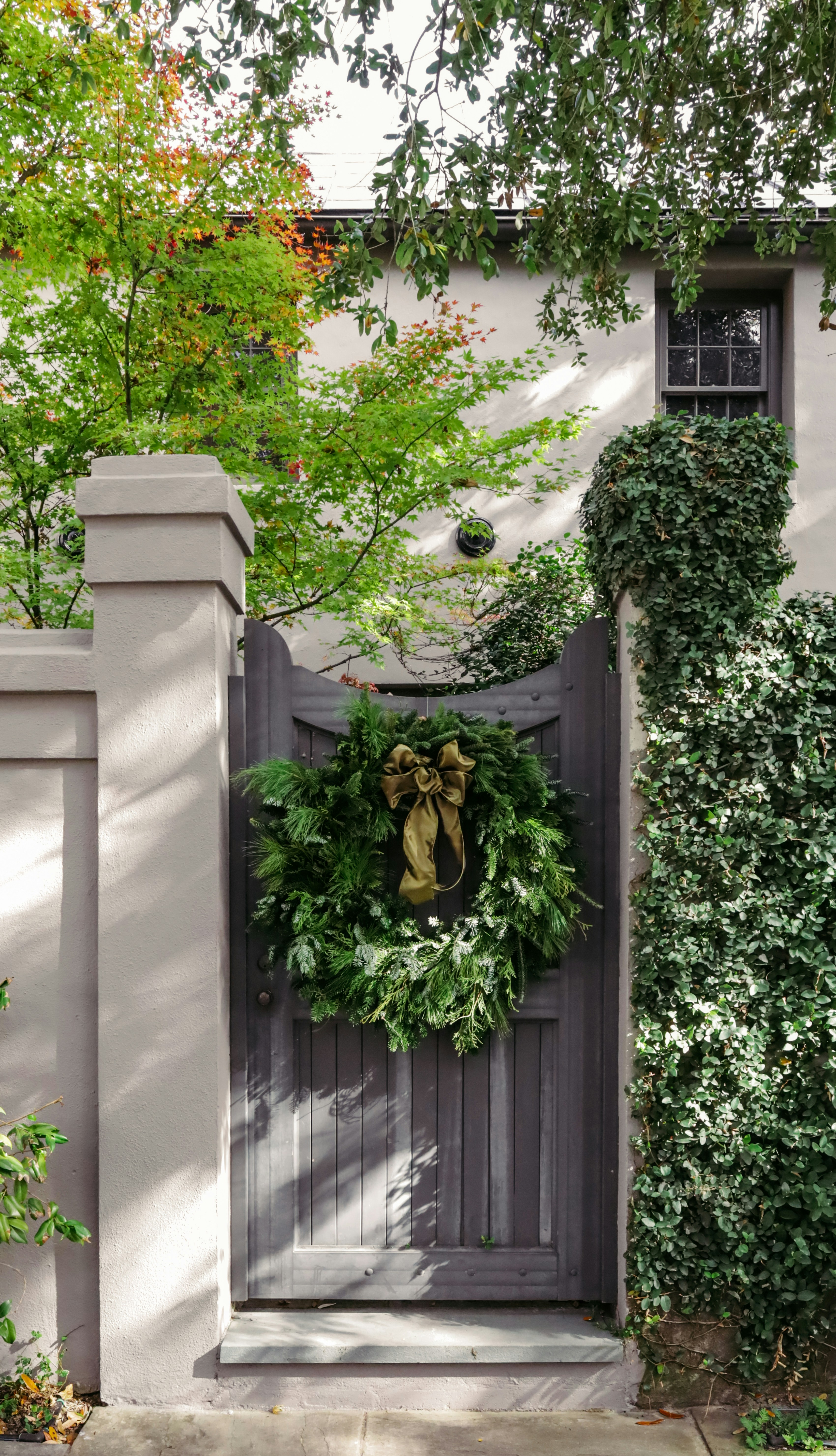 Wreath at the Gate: Emerald Vines Framing a Quiet Doorway