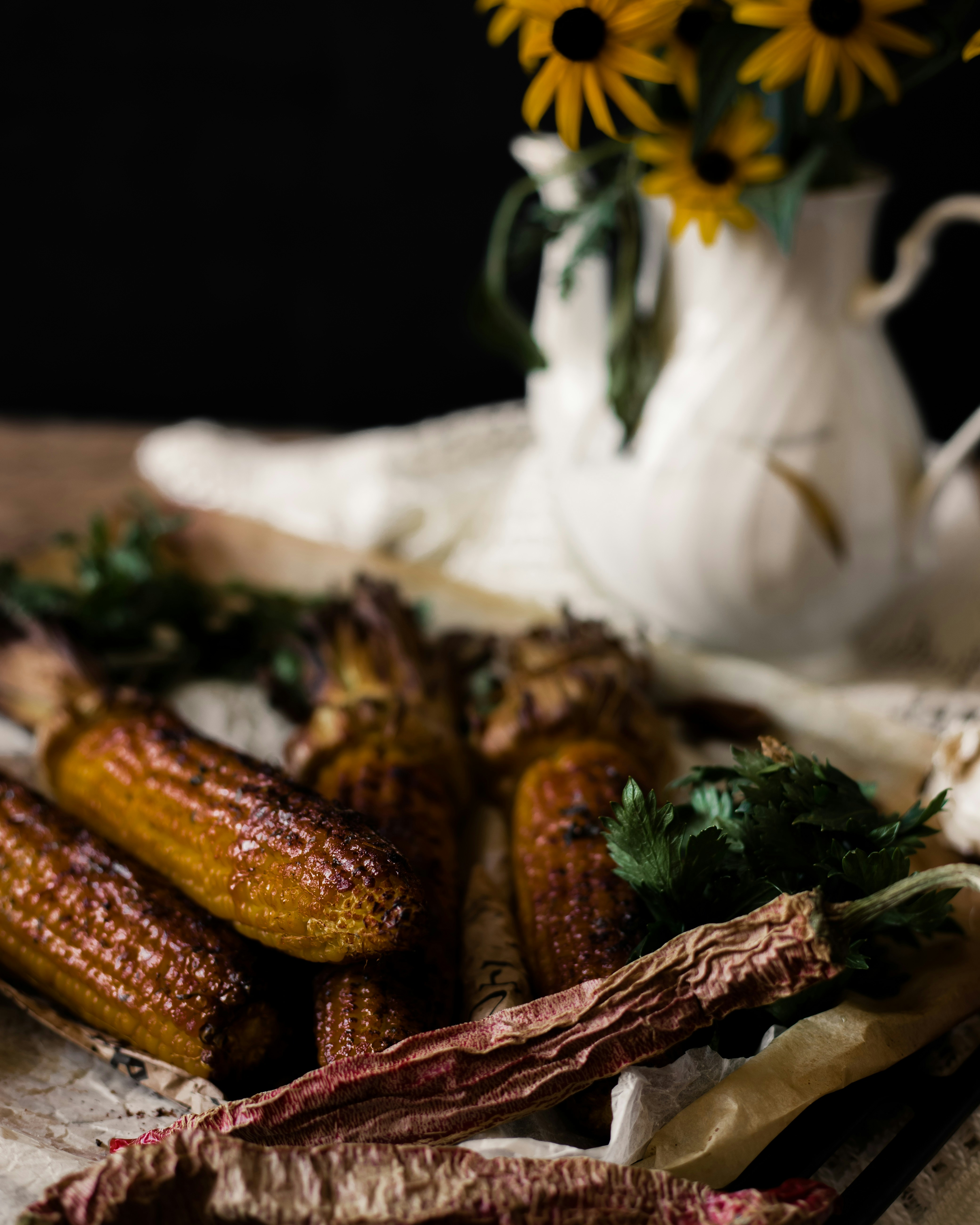 Charred Caramel Corn on a Rustic Tray with Sunflowers in the Background