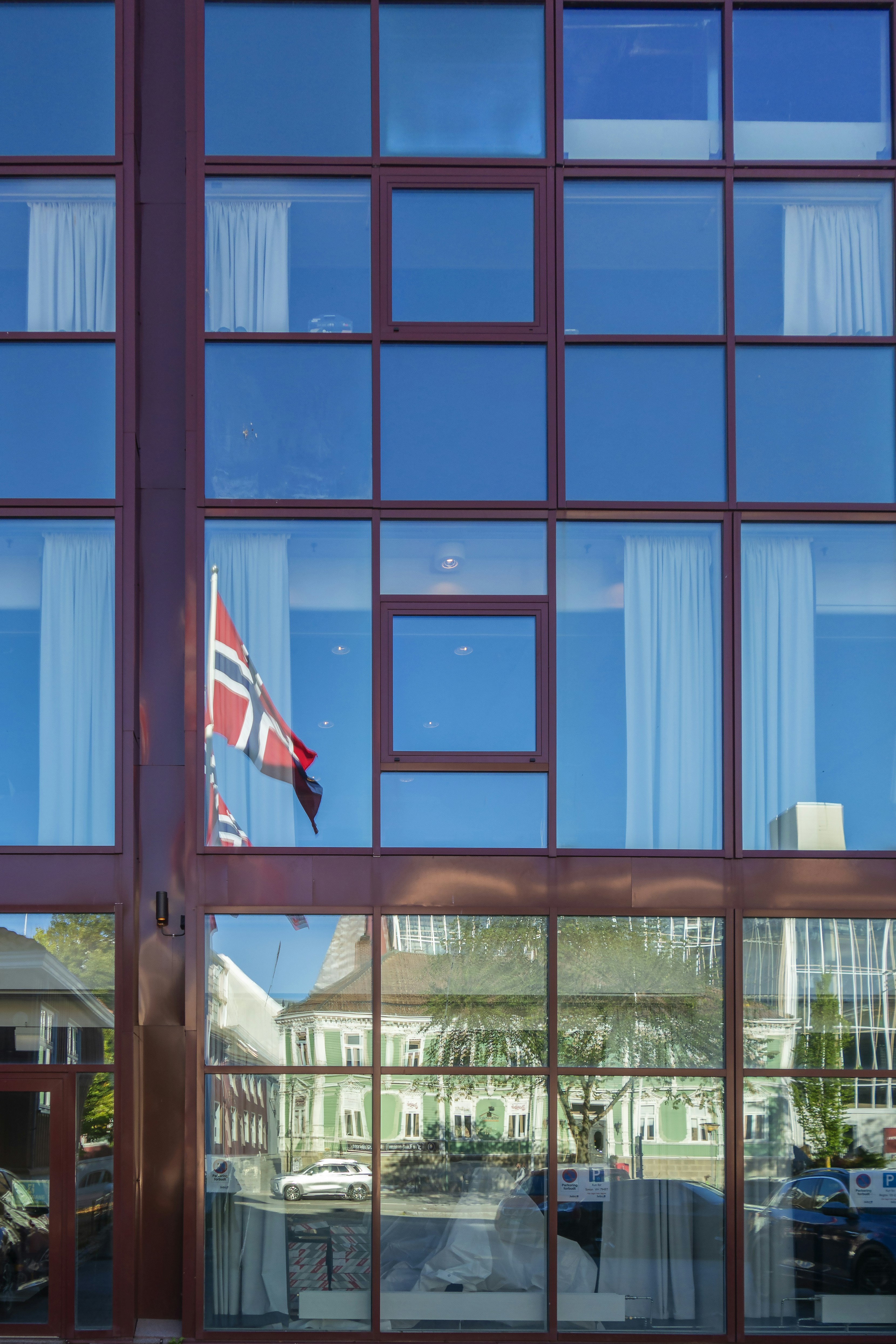 The reflection of a flag in the windows of a building photo – Free ...