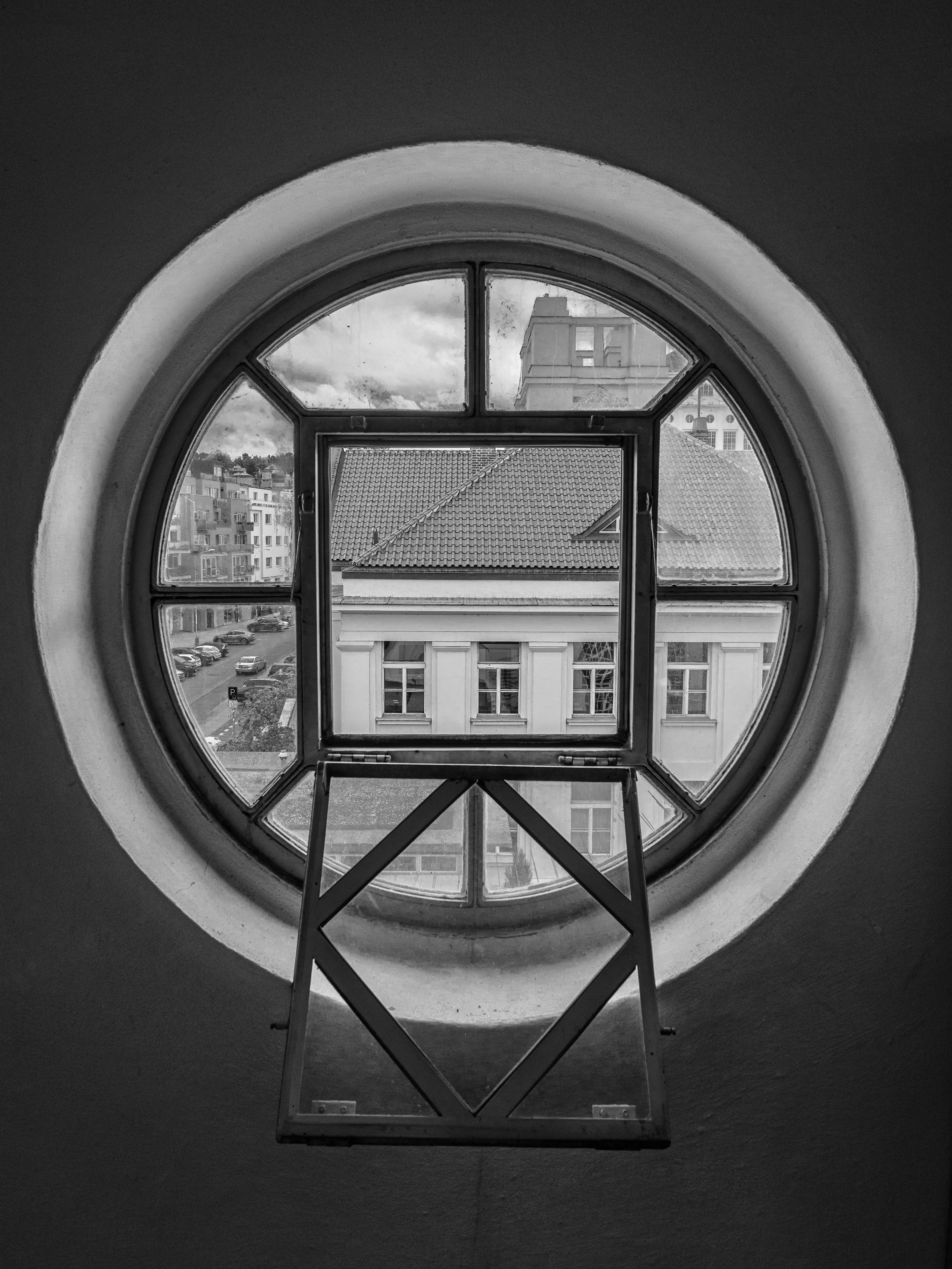 A circular window with a view of a building photo – Free Grey Image on ...