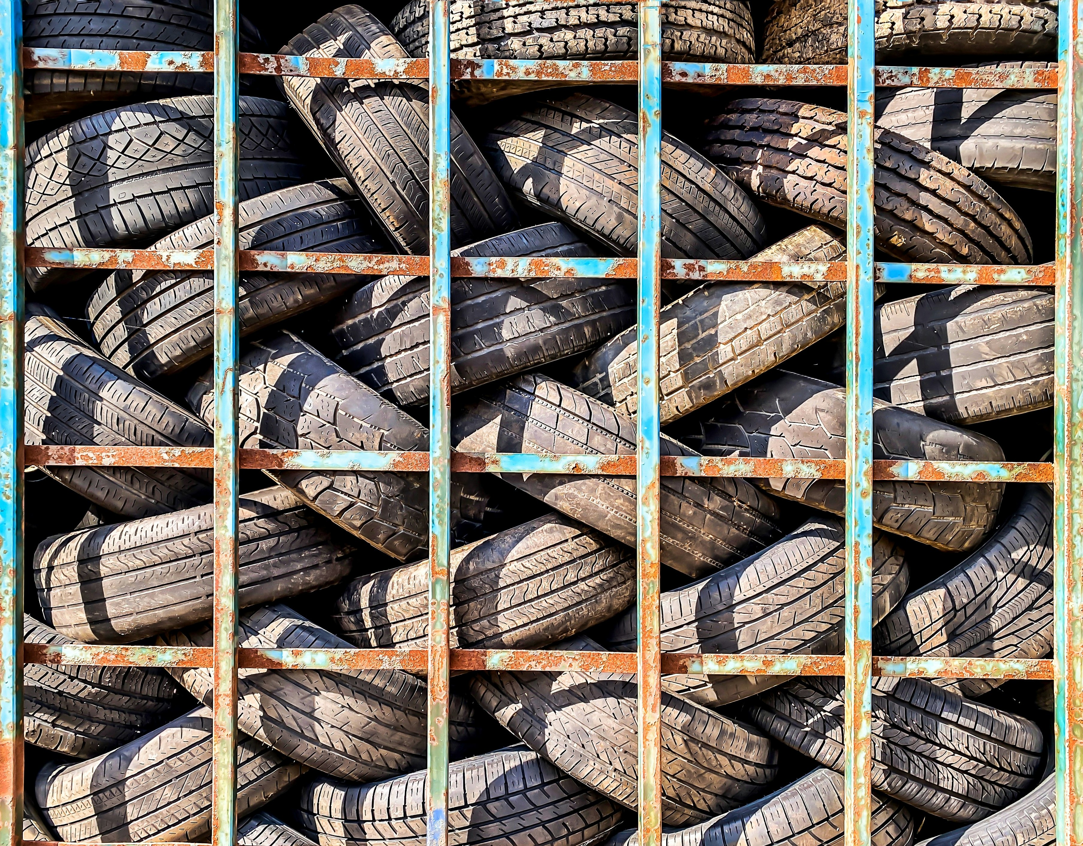 A bunch of old tires stacked on top of each other photo – Free White ...