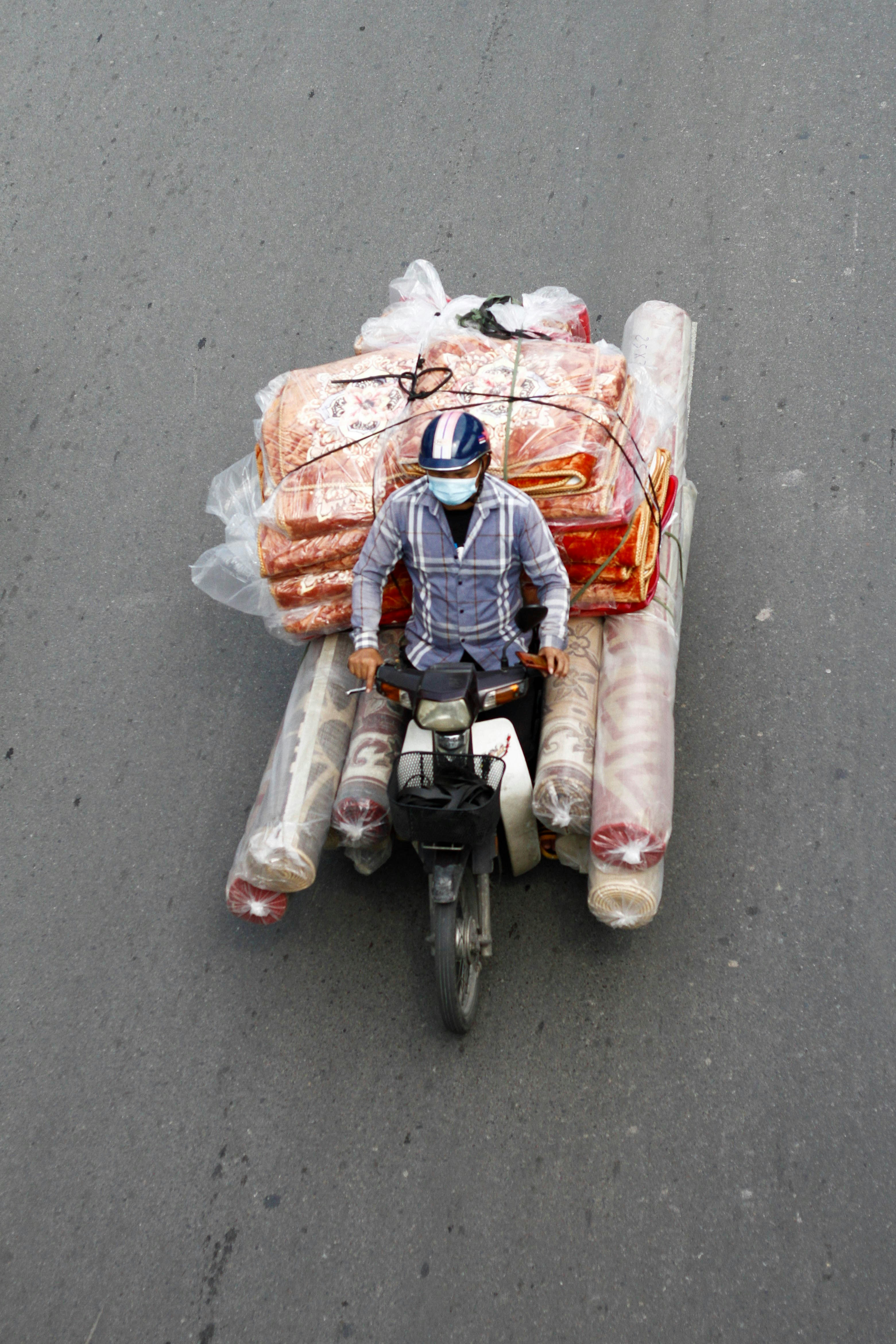 Carpet Caravan: Top-Down Haul on a Motorbike