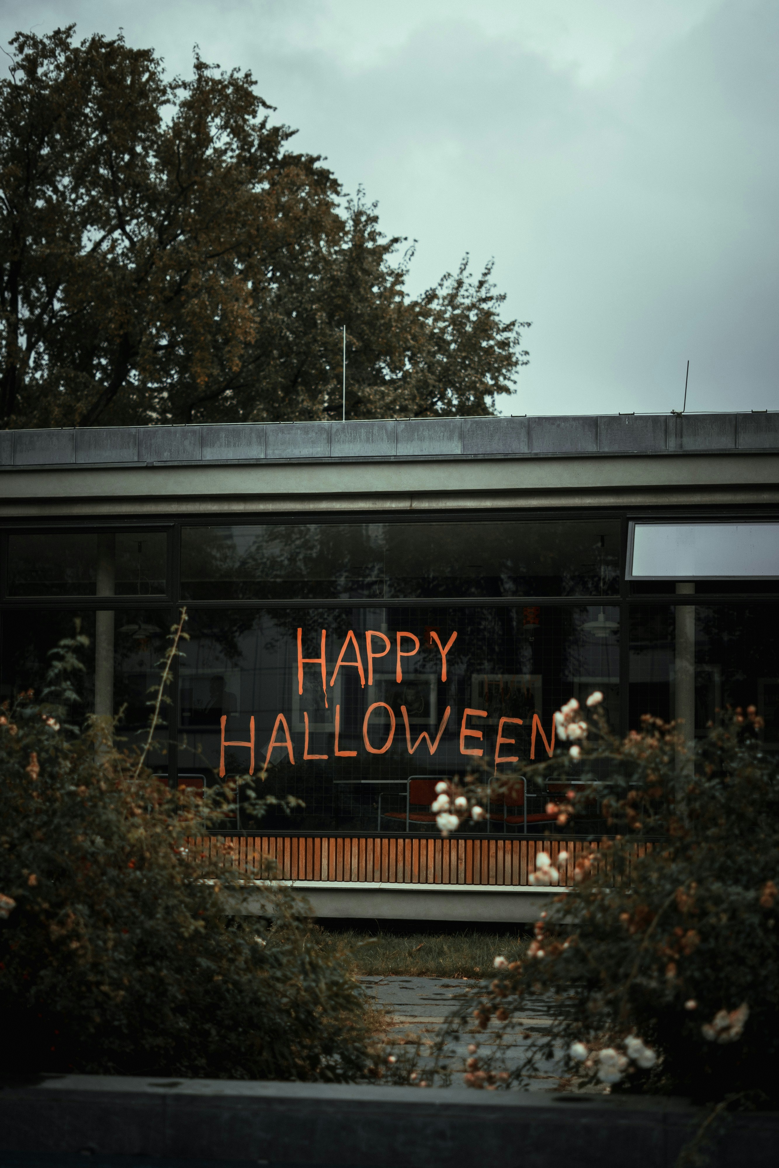 a sign that says happy halloween on the side of a building
