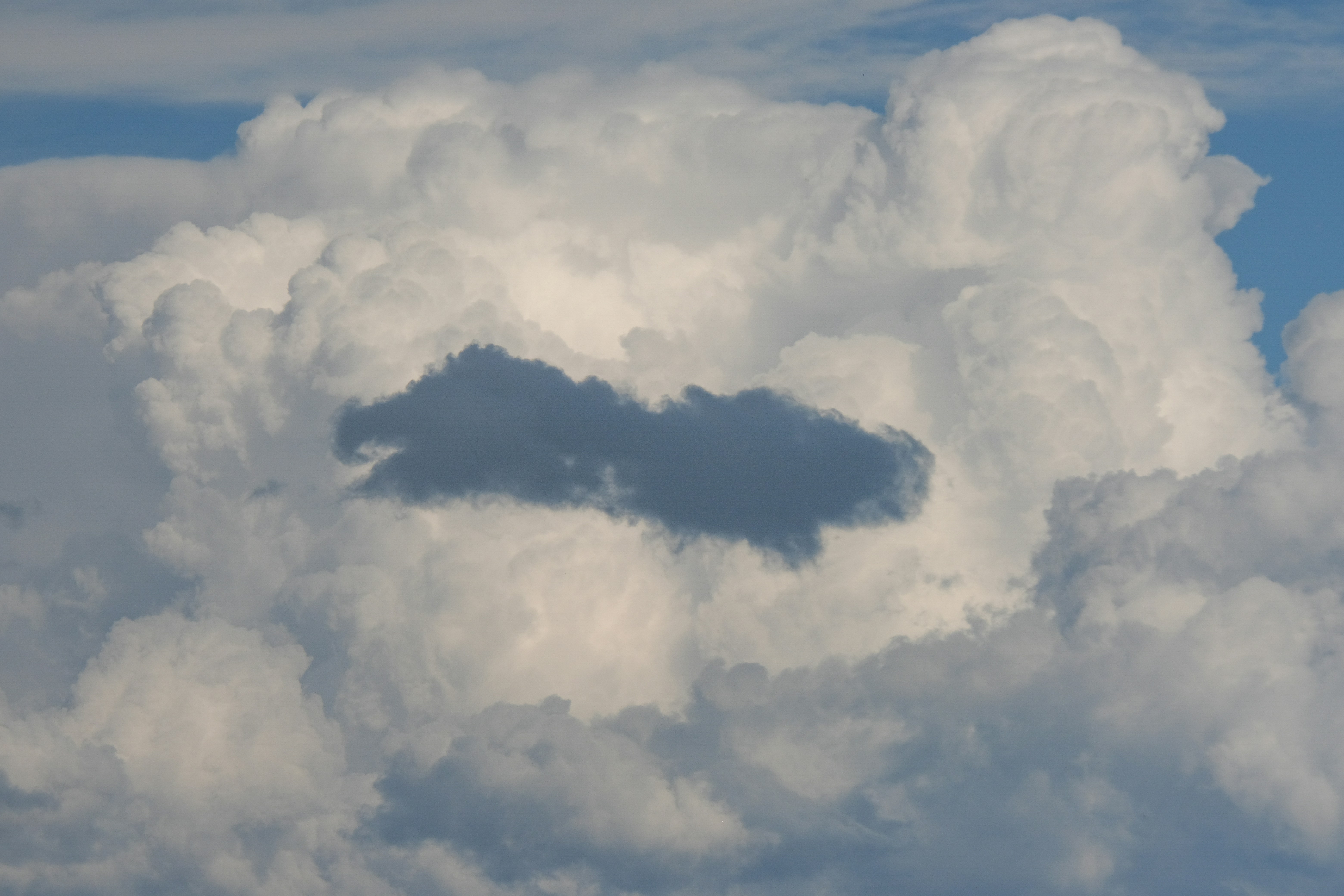 Dark Window in the Sky: A Quiet Gap Carved Through Brushed Clouds