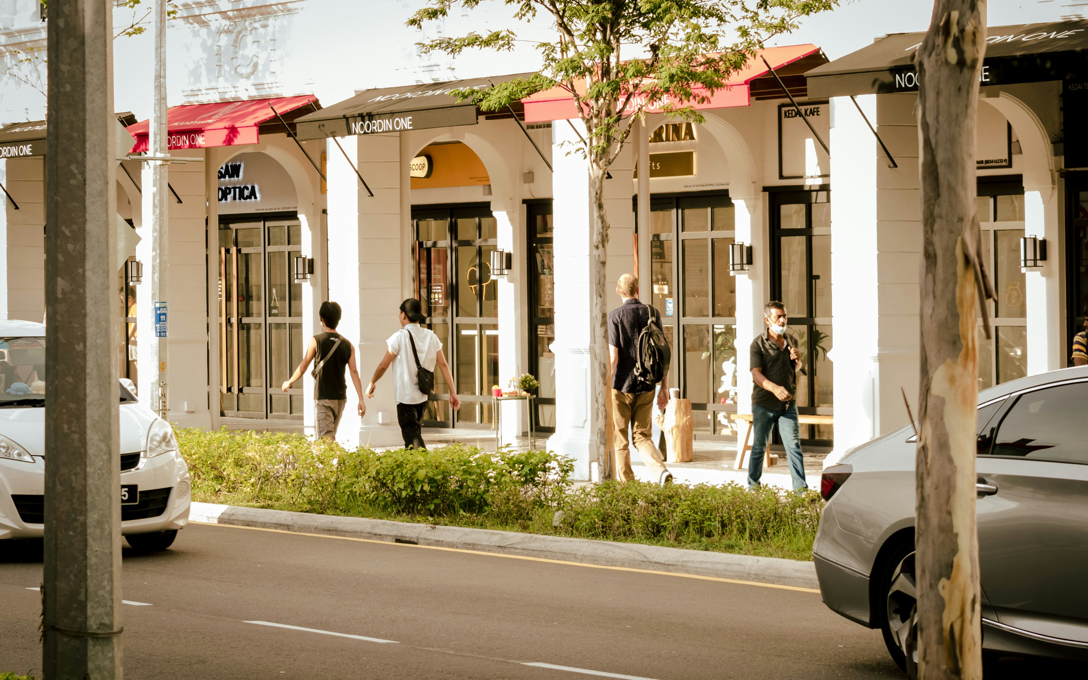 a group of people walking down a street next to a building