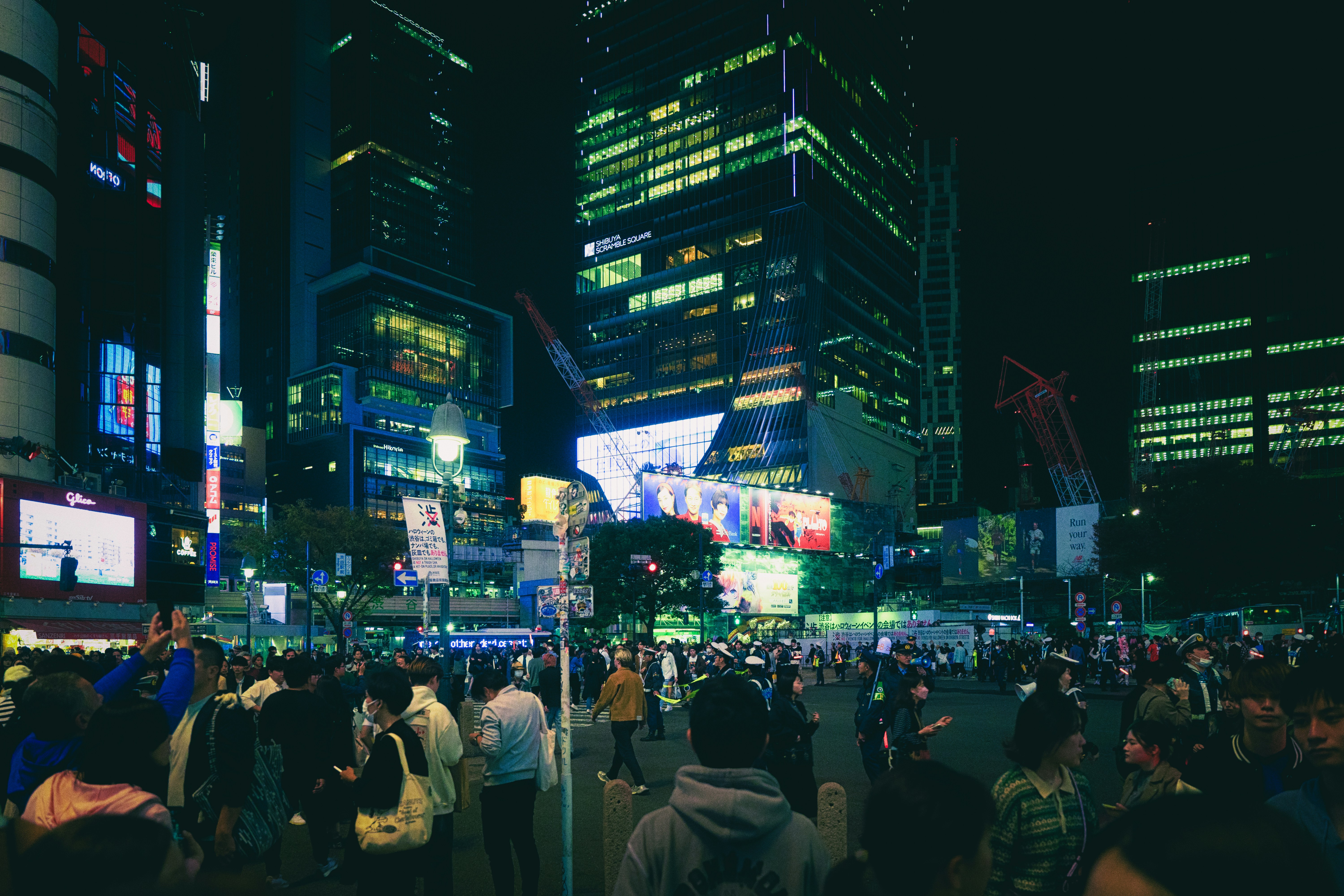 A crowd of people standing on a street at night photo – Free 2-3 ...