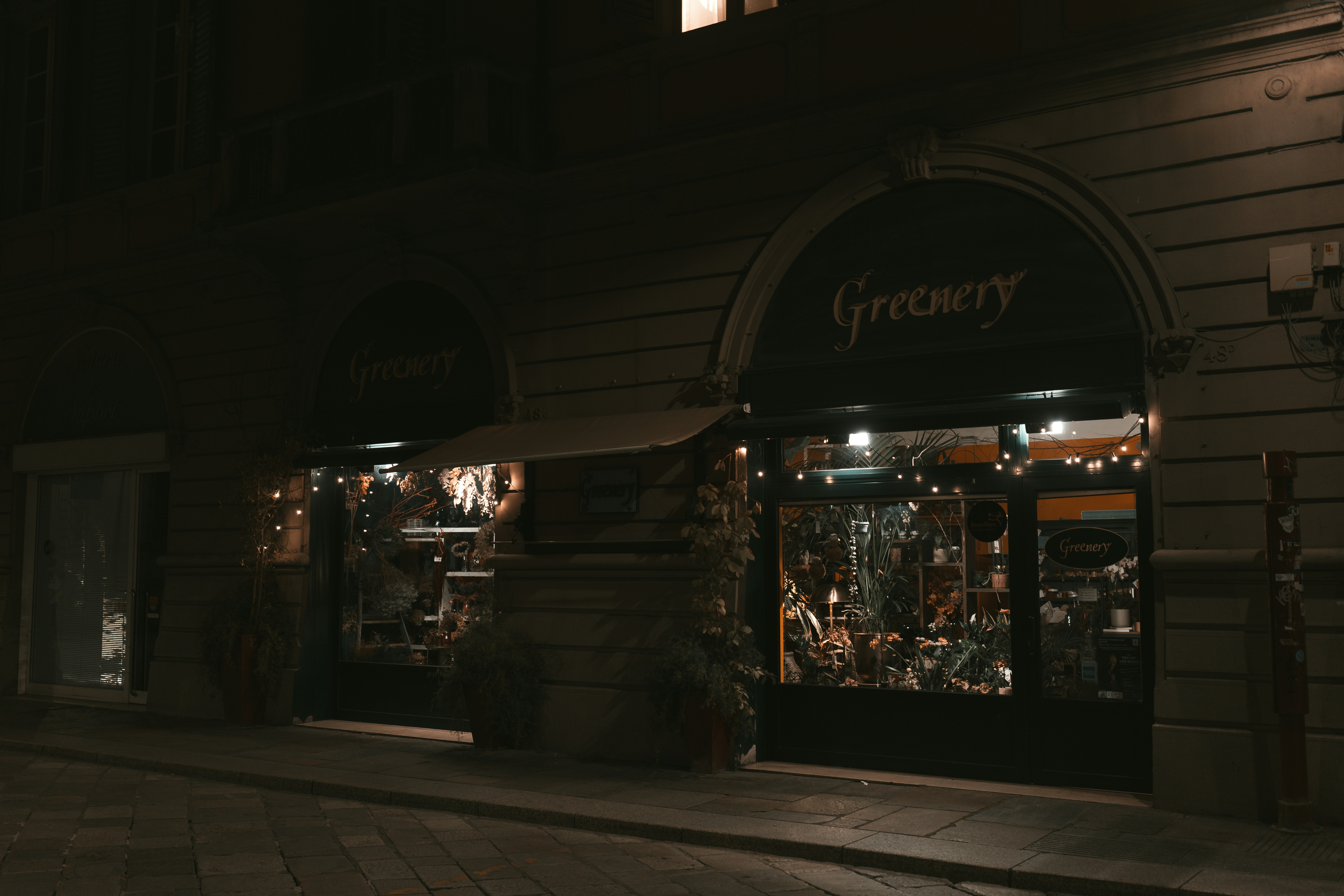 A store front at night with lights on photo – Free City Image on Unsplash