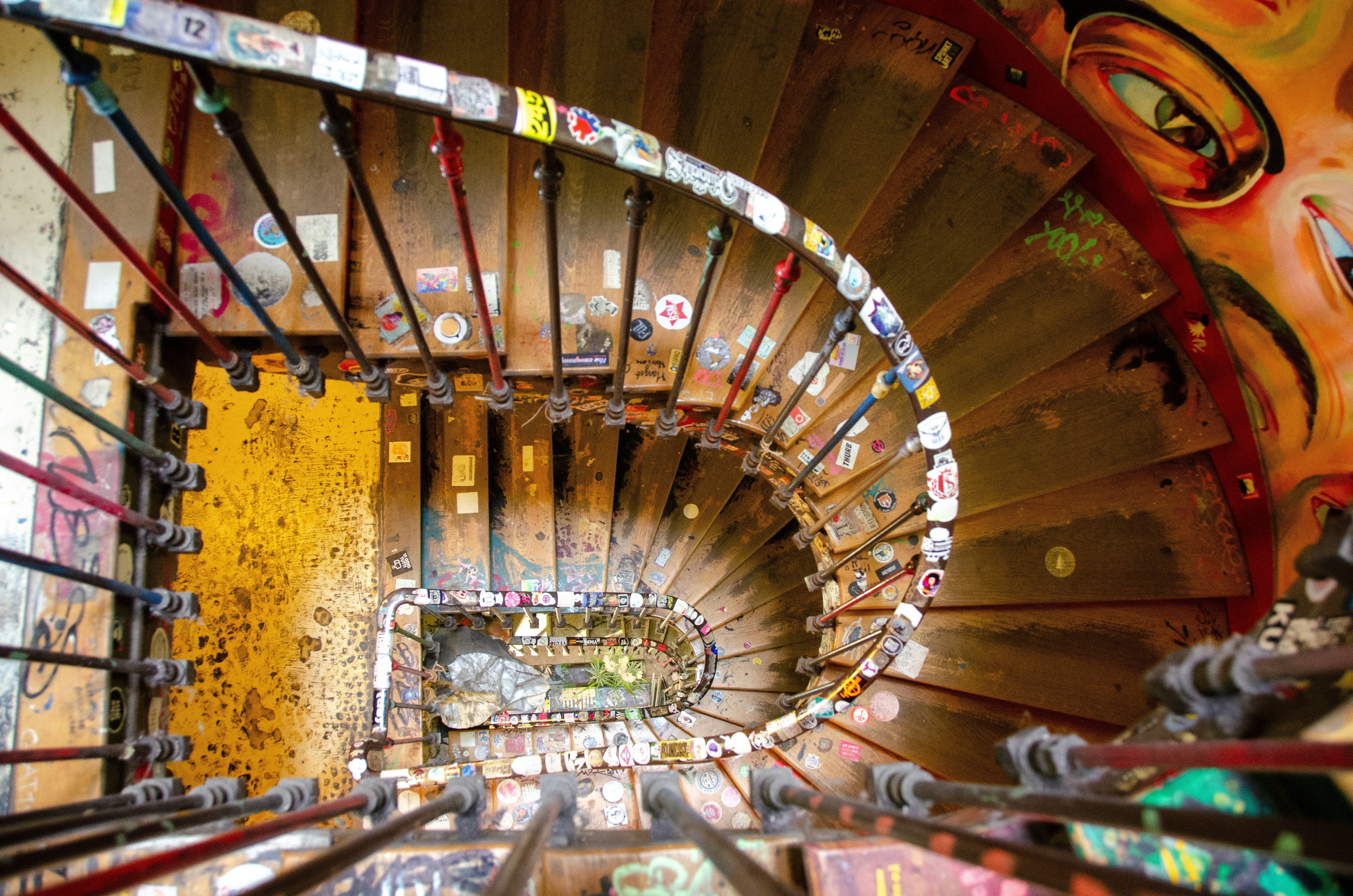 A spiral staircase with lots of stickers on it photo – Free 59 rivoli ...