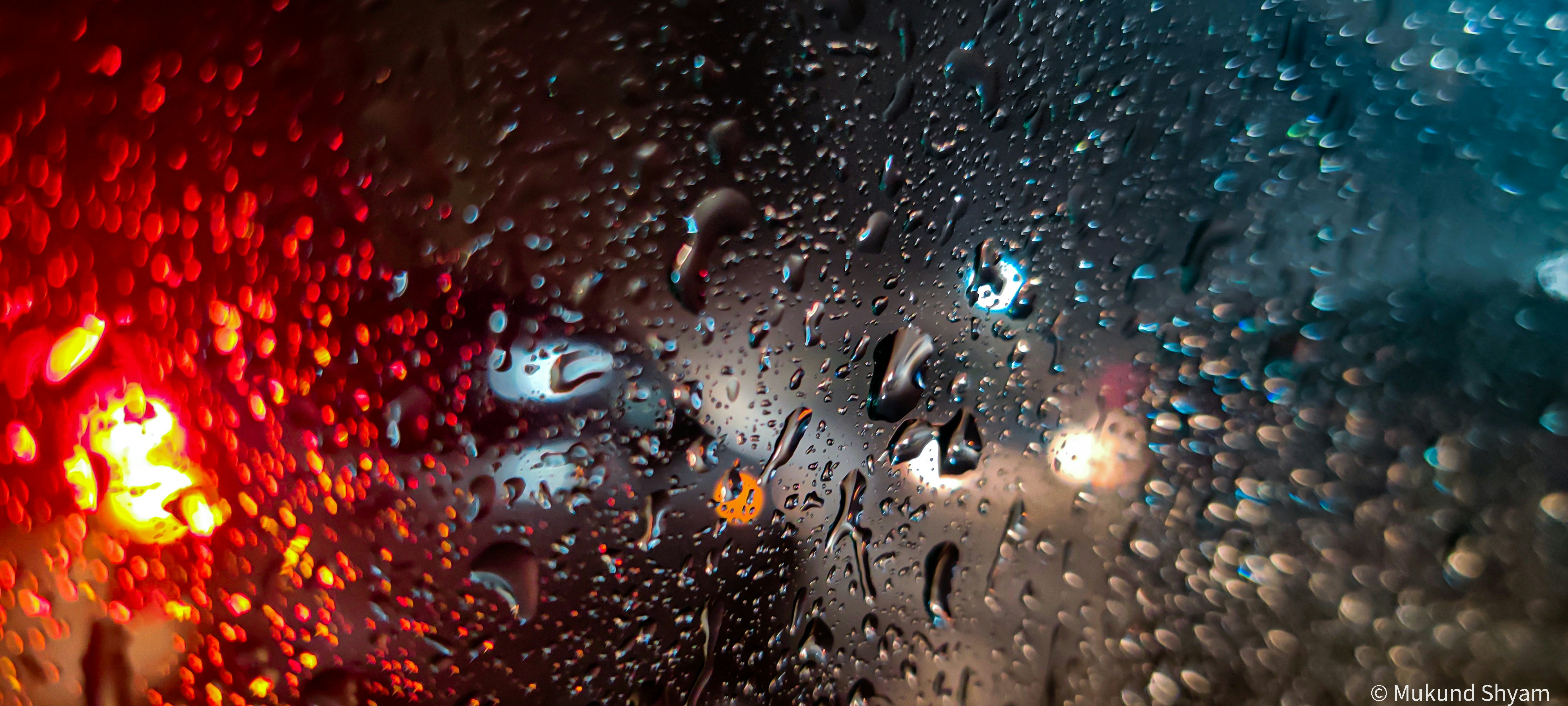 Neon Rain Through a Wet Windshield: Red and Blue City Lights
