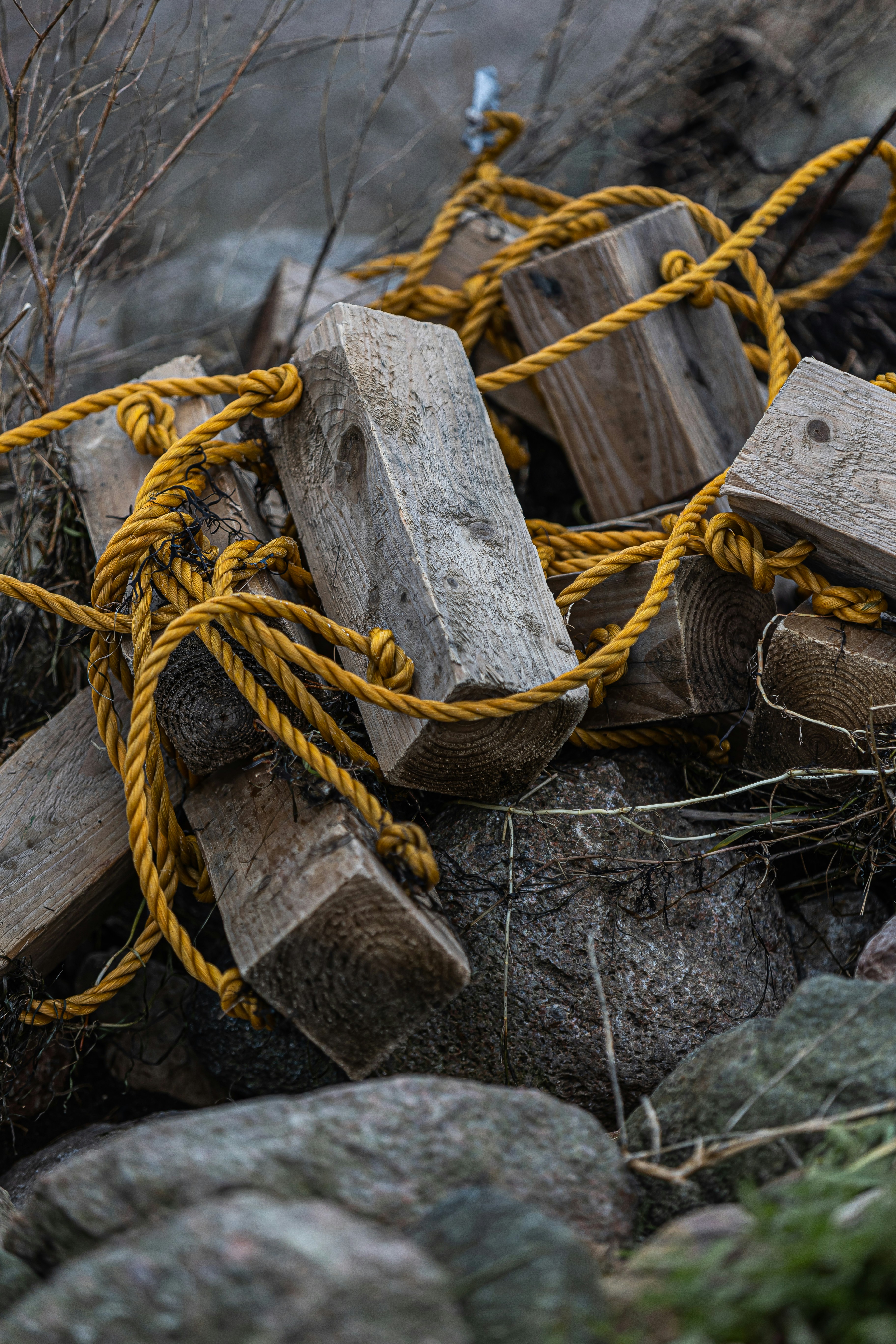 A pile of wood blocks and ropes on a rocky hillside photo – Free ...