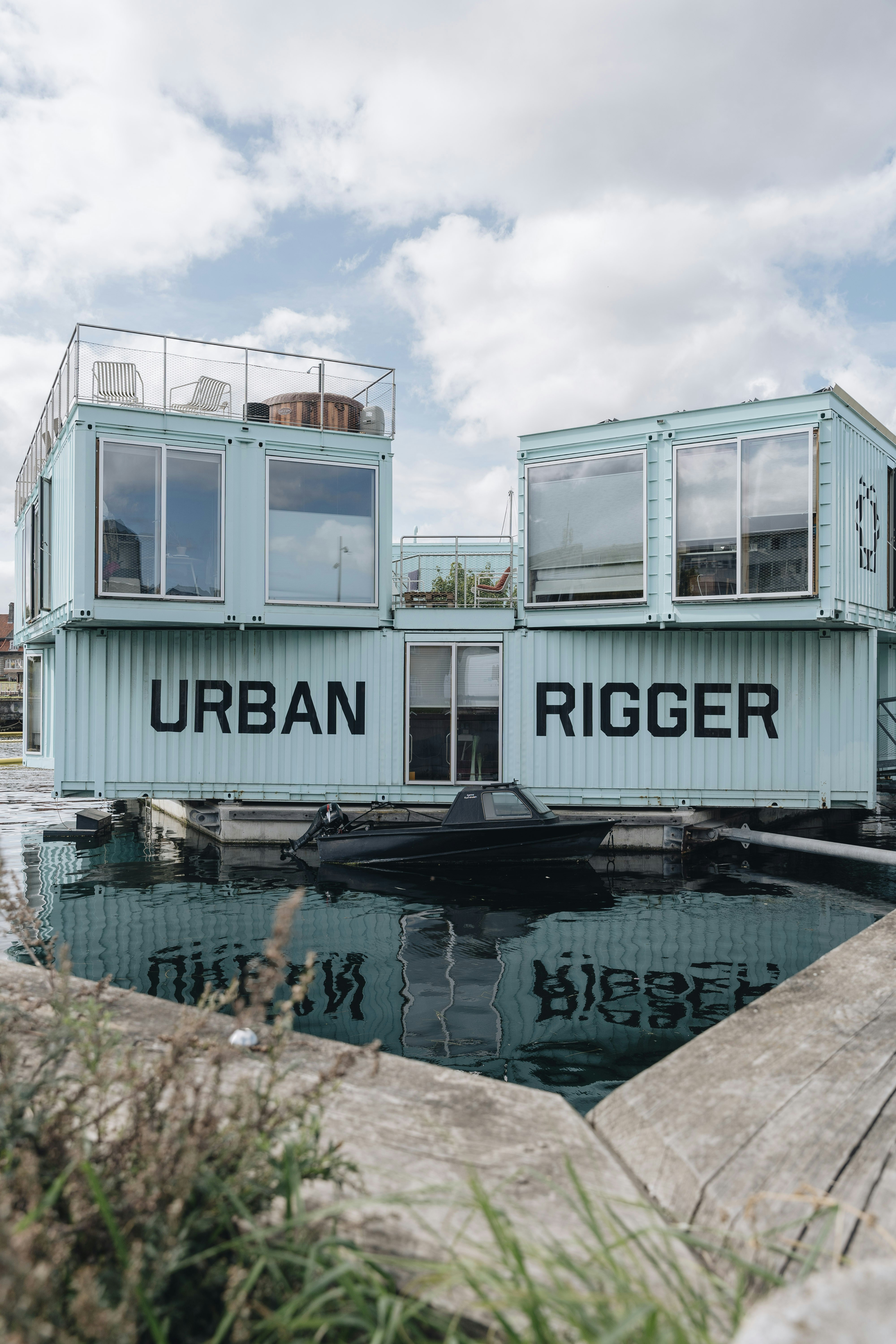 A couple of shipping containers sitting on top of a body of water photo ...