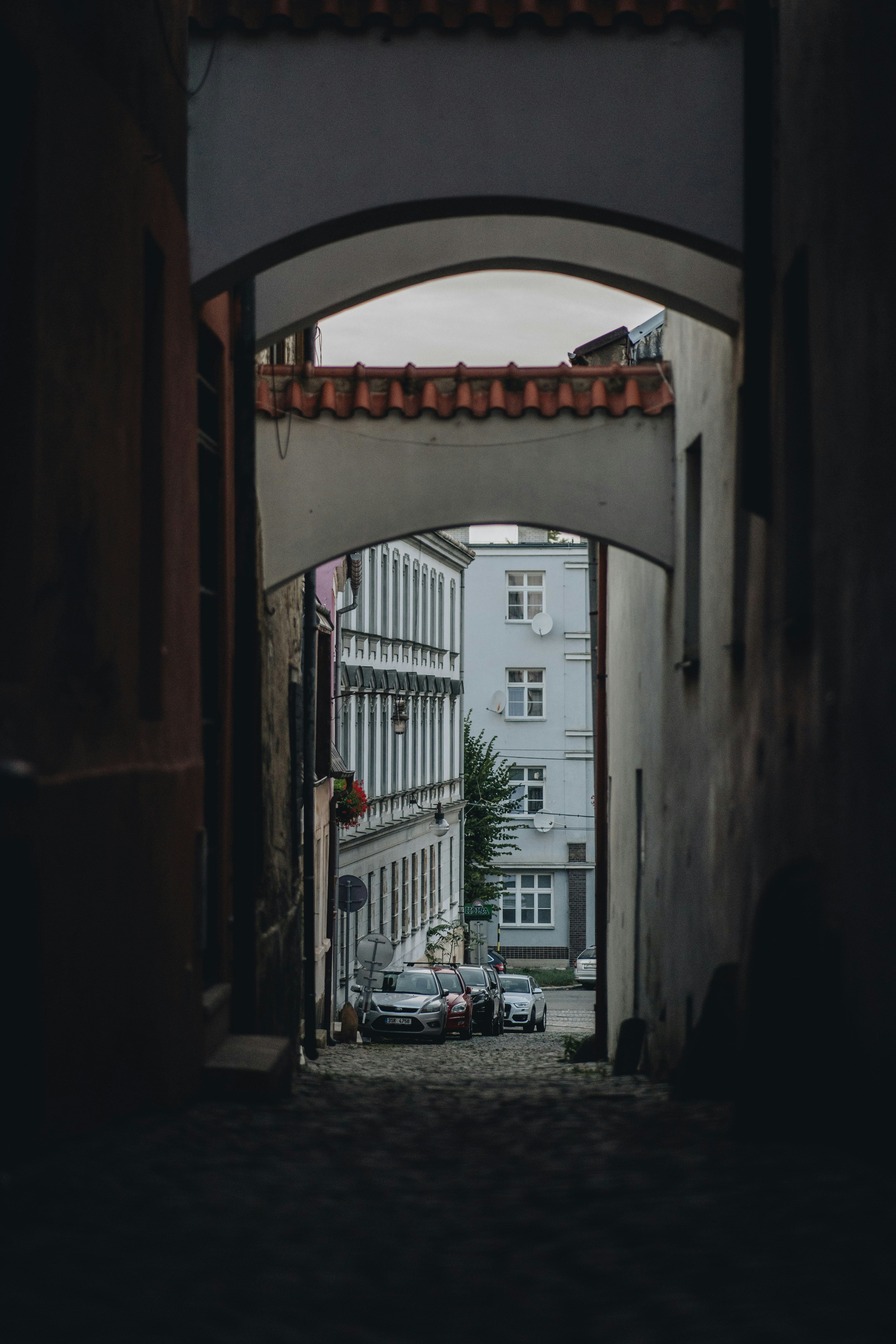 Through the Archway: Cobblestones Lead to a Quiet Street