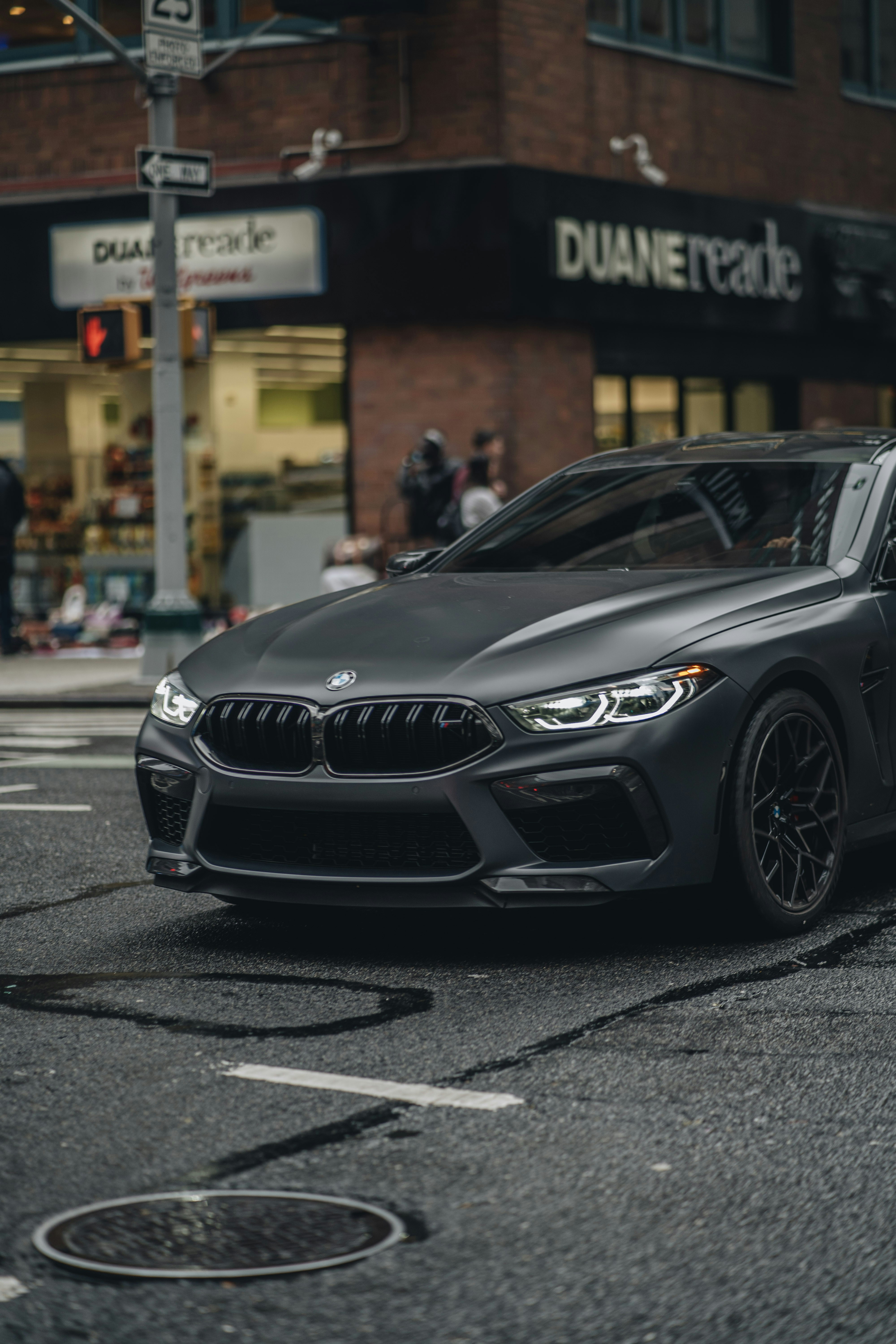 Urban Velocity: Matte Gray BMW at a City Corner