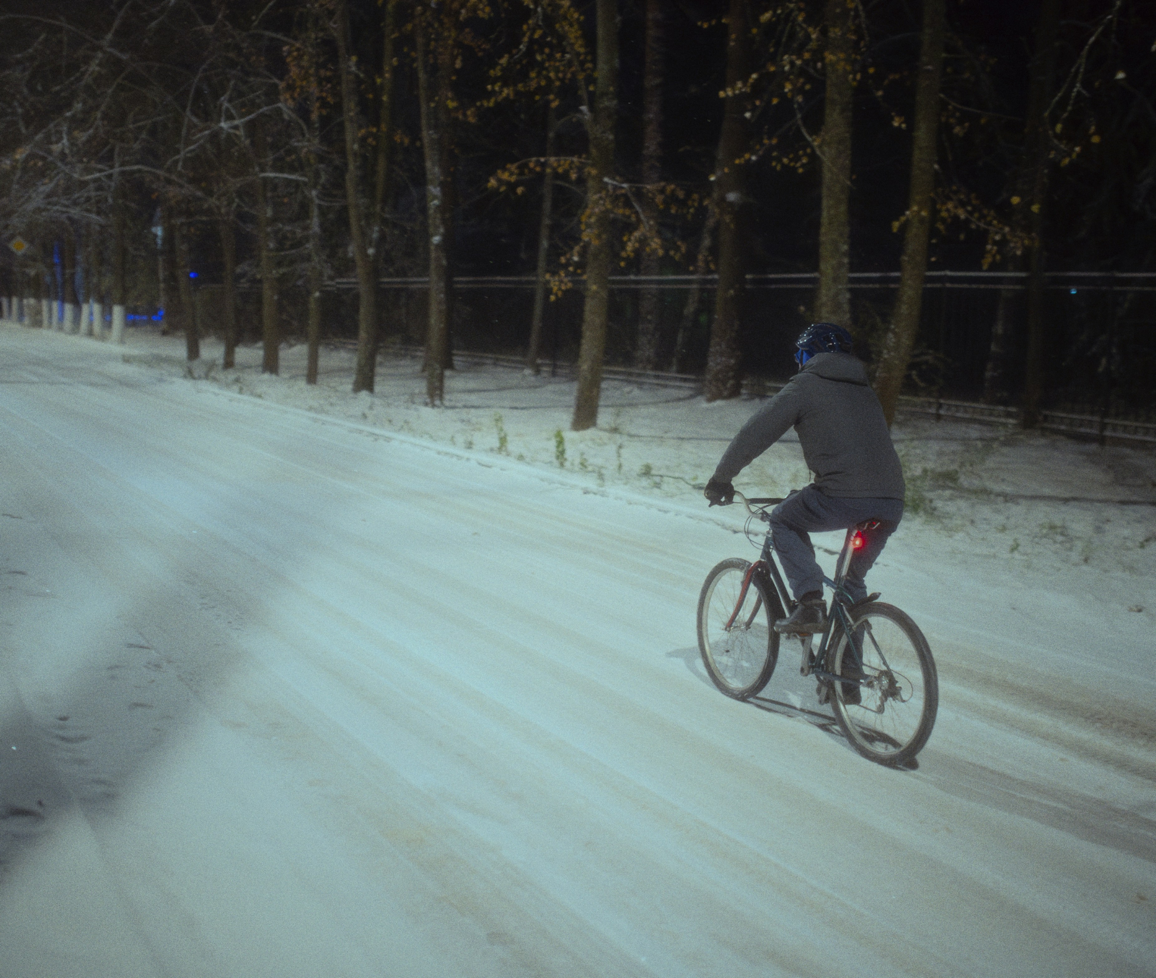 Night Ride on Icy Road: A Lone Biker Defies the Snow