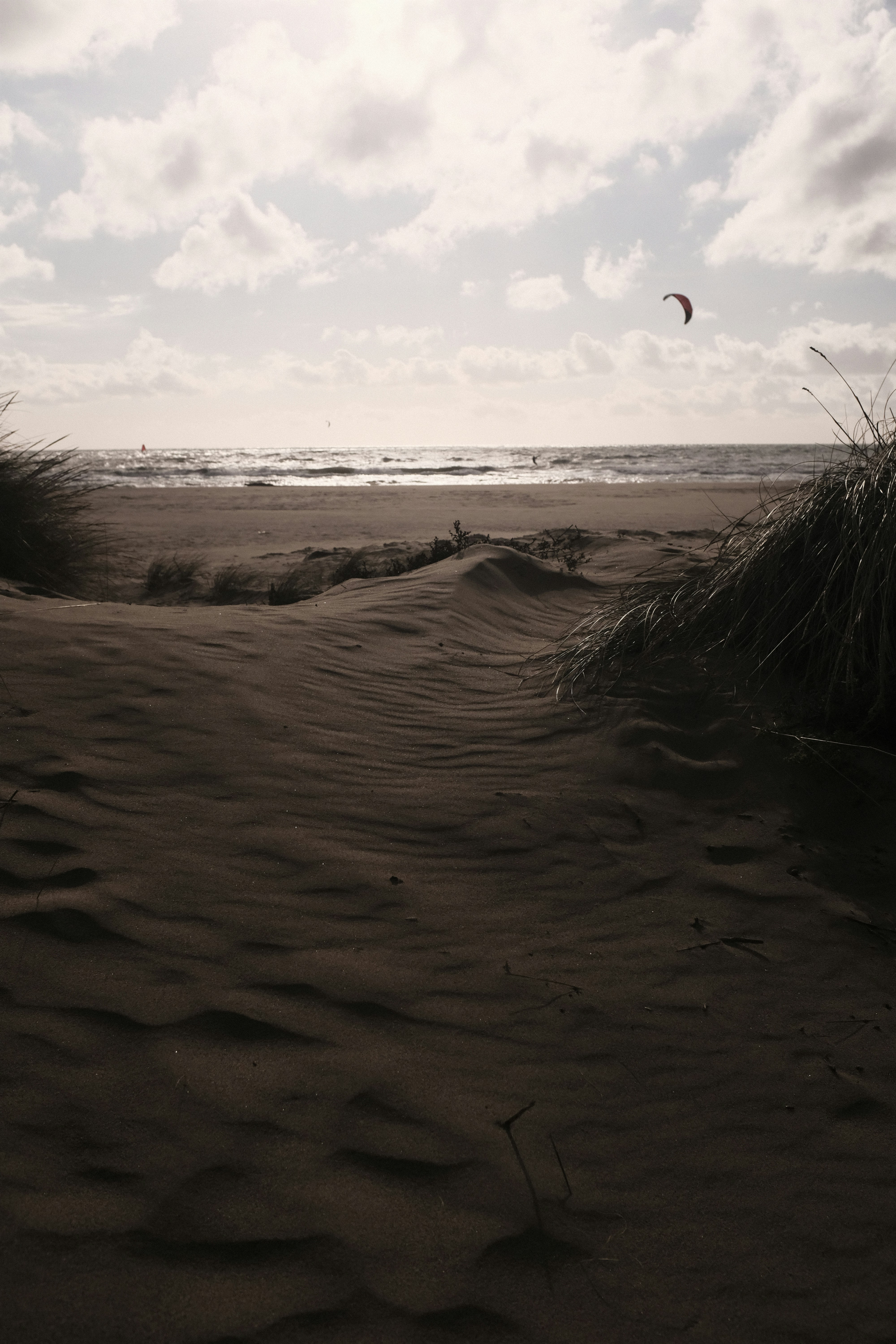 Kite over Wind-Sculpted Dunes at Dusk