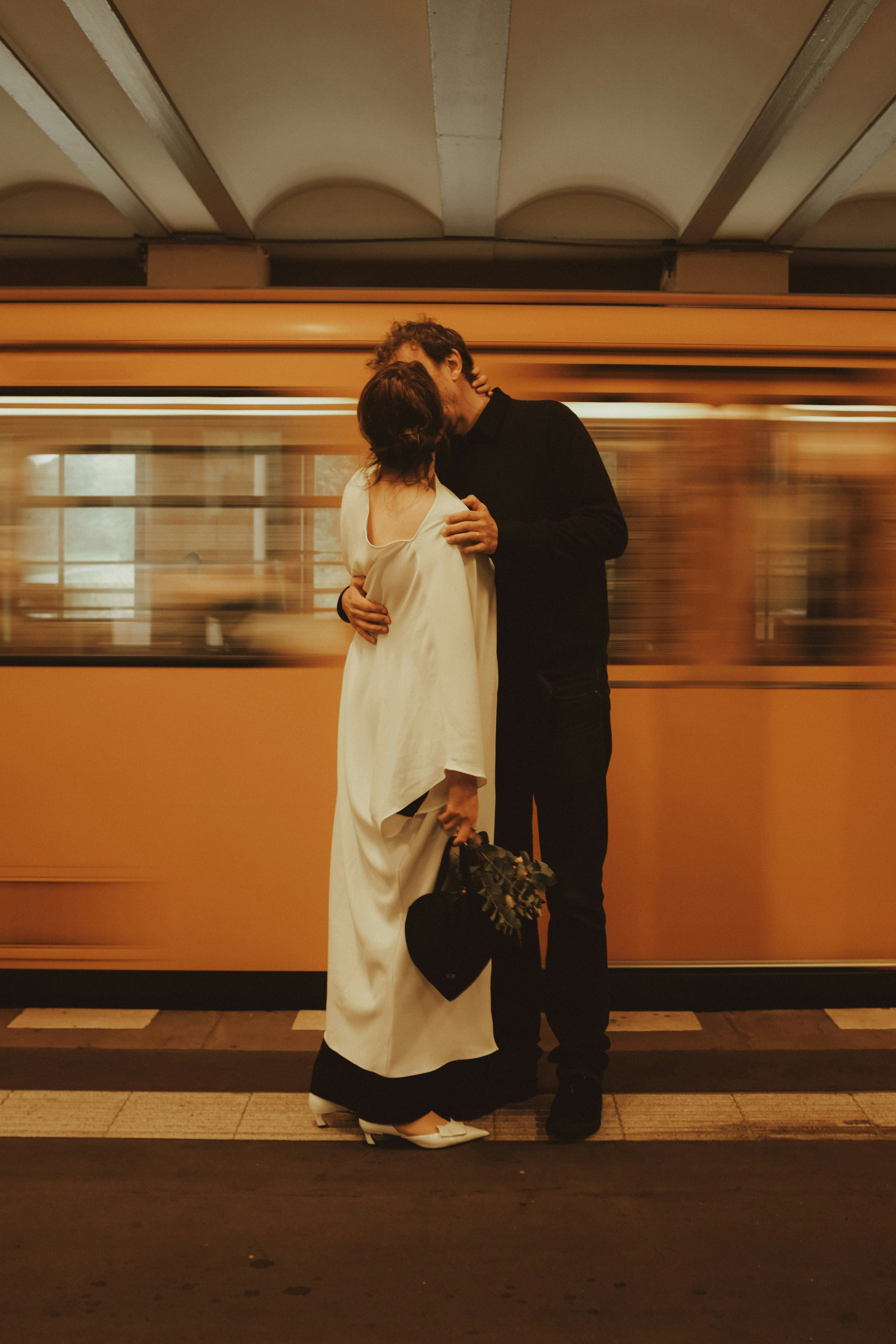 A man and a woman standing next to a train photo – Free Berlin Image on ...