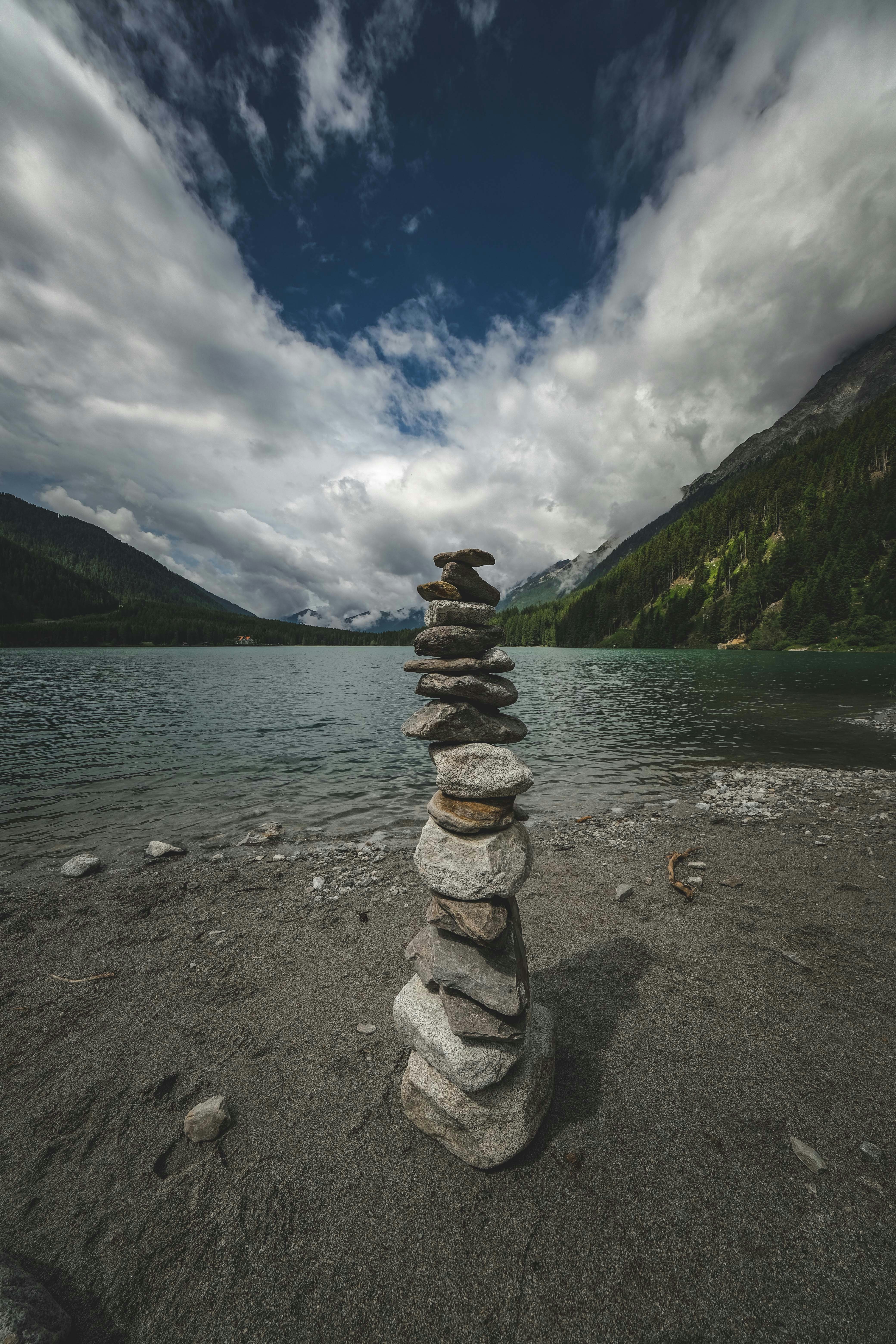 A stack of rocks sitting on top of a sandy beach photo – Free Grey ...