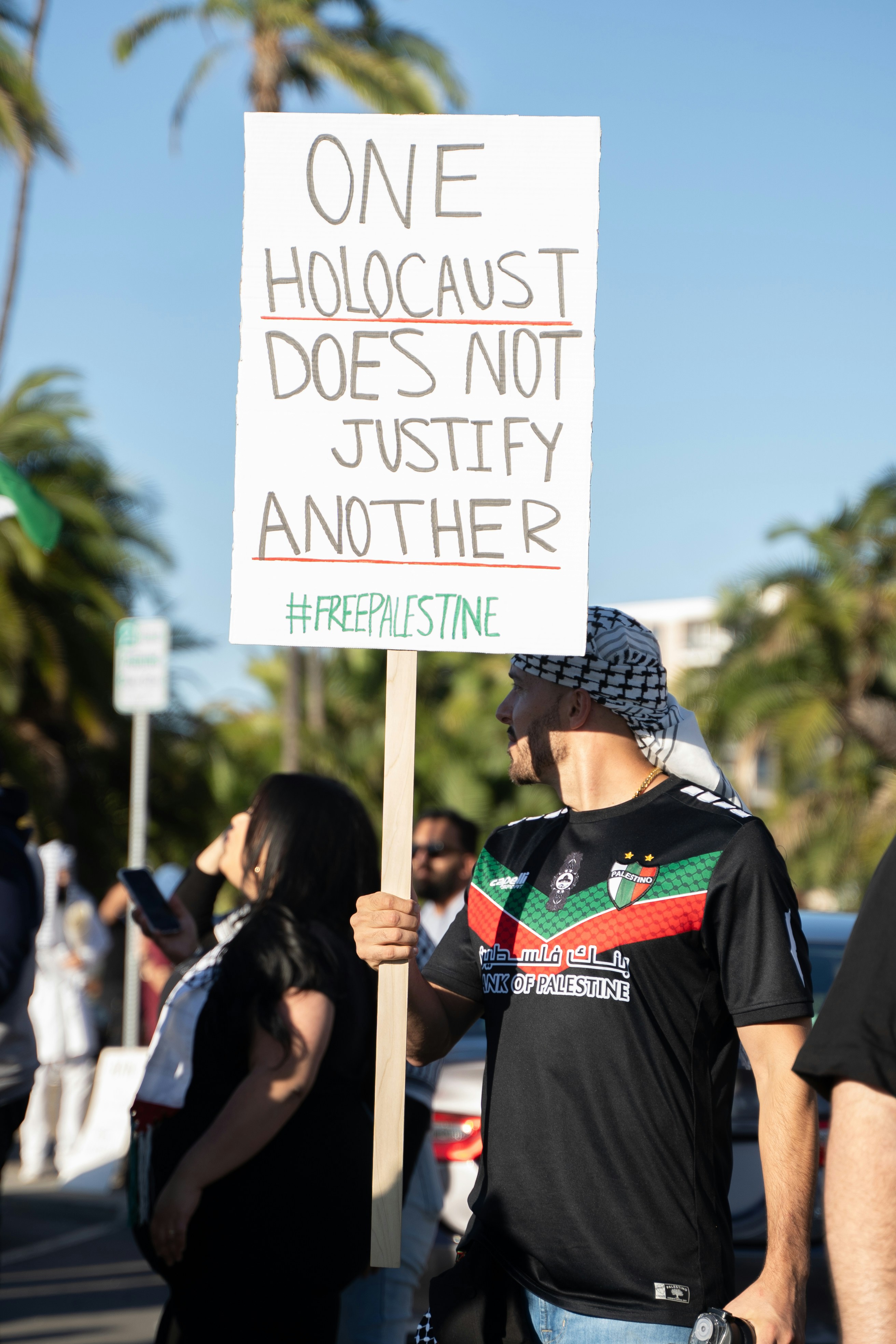Sign Carrier at a Peaceful Rally: One Holocaust Does Not Justify Another