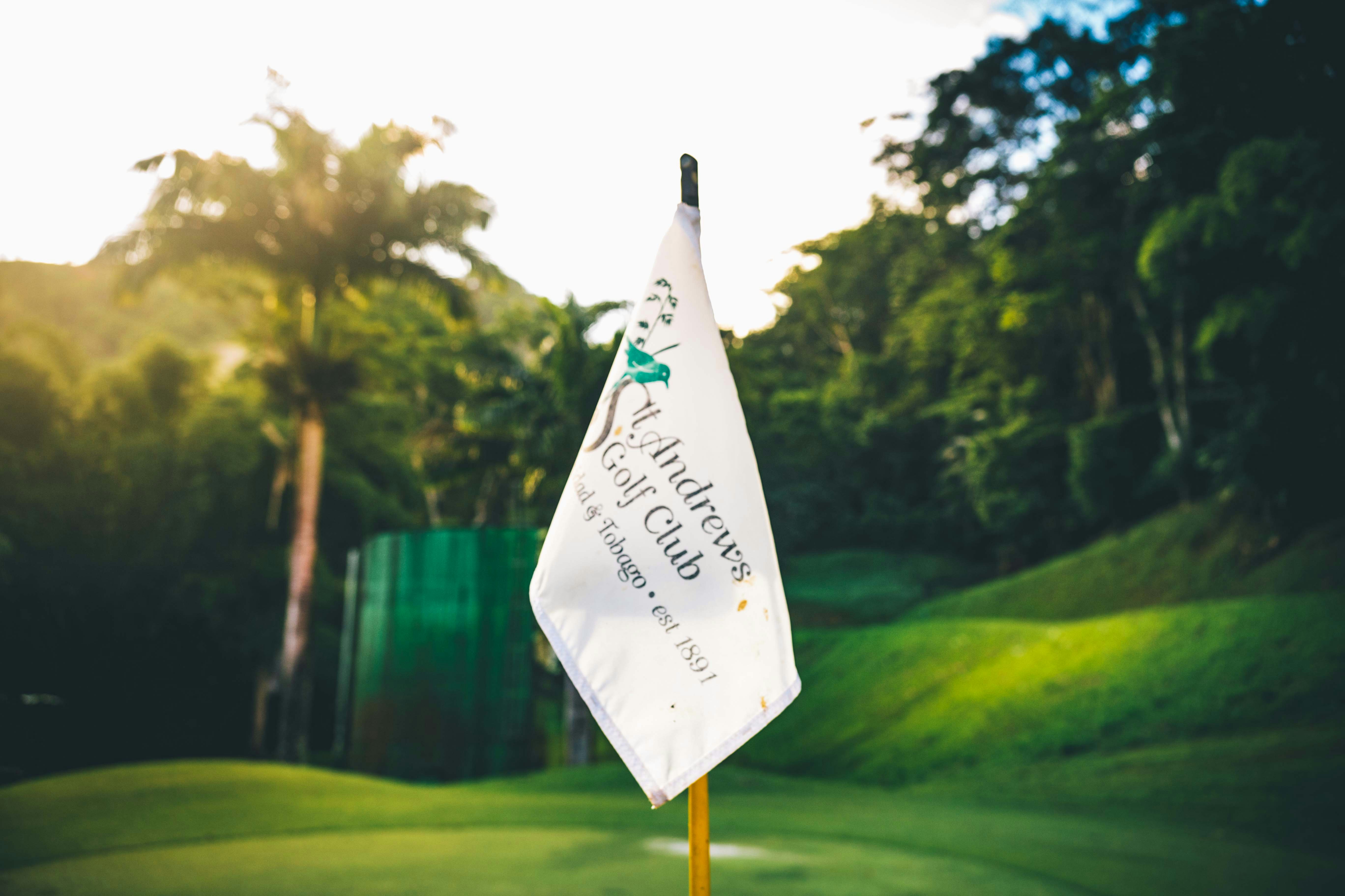 Golden Hour Flag Marker on a Tranquil Golf Tee